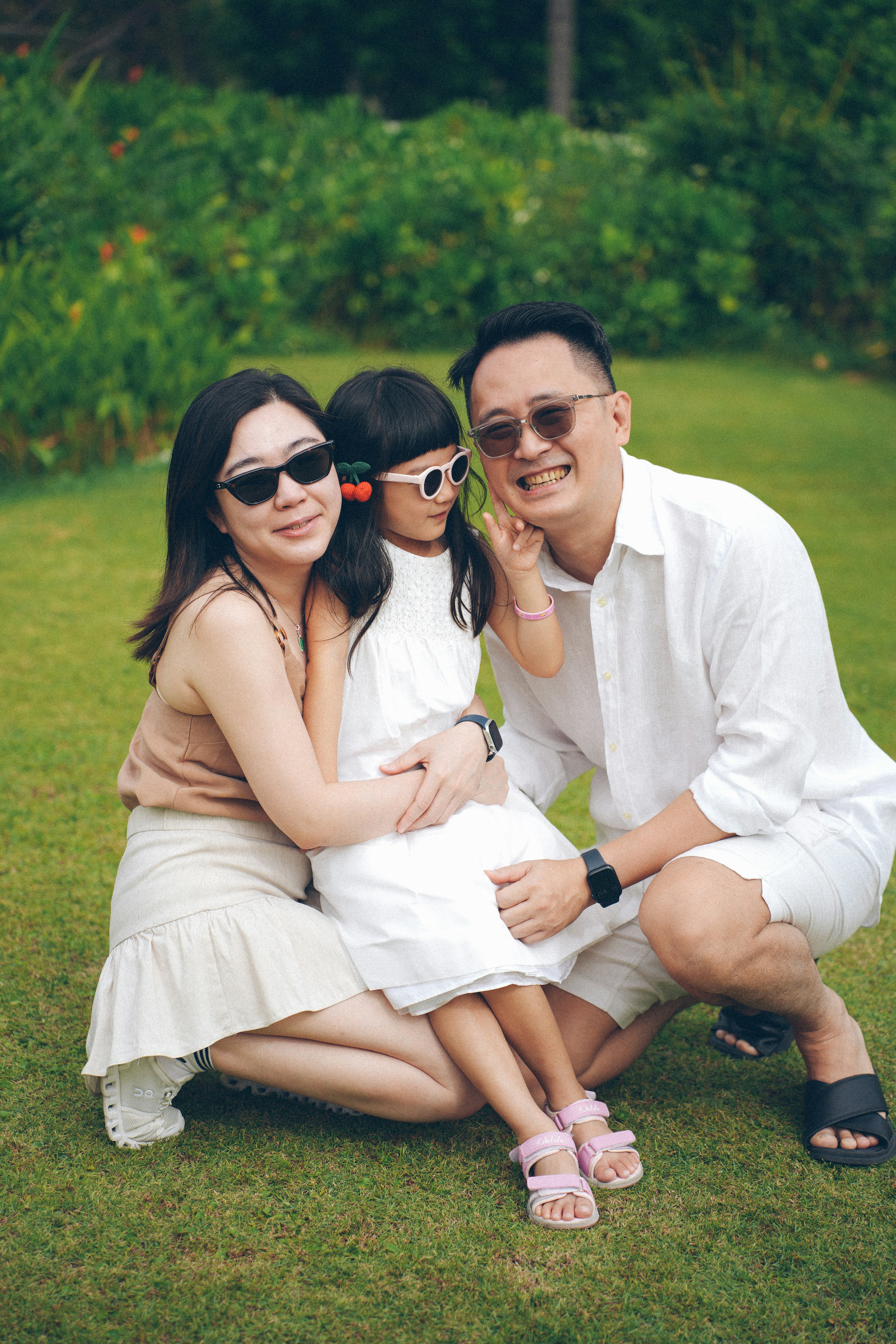 Sunlit Family Portrait in a Lush Garden