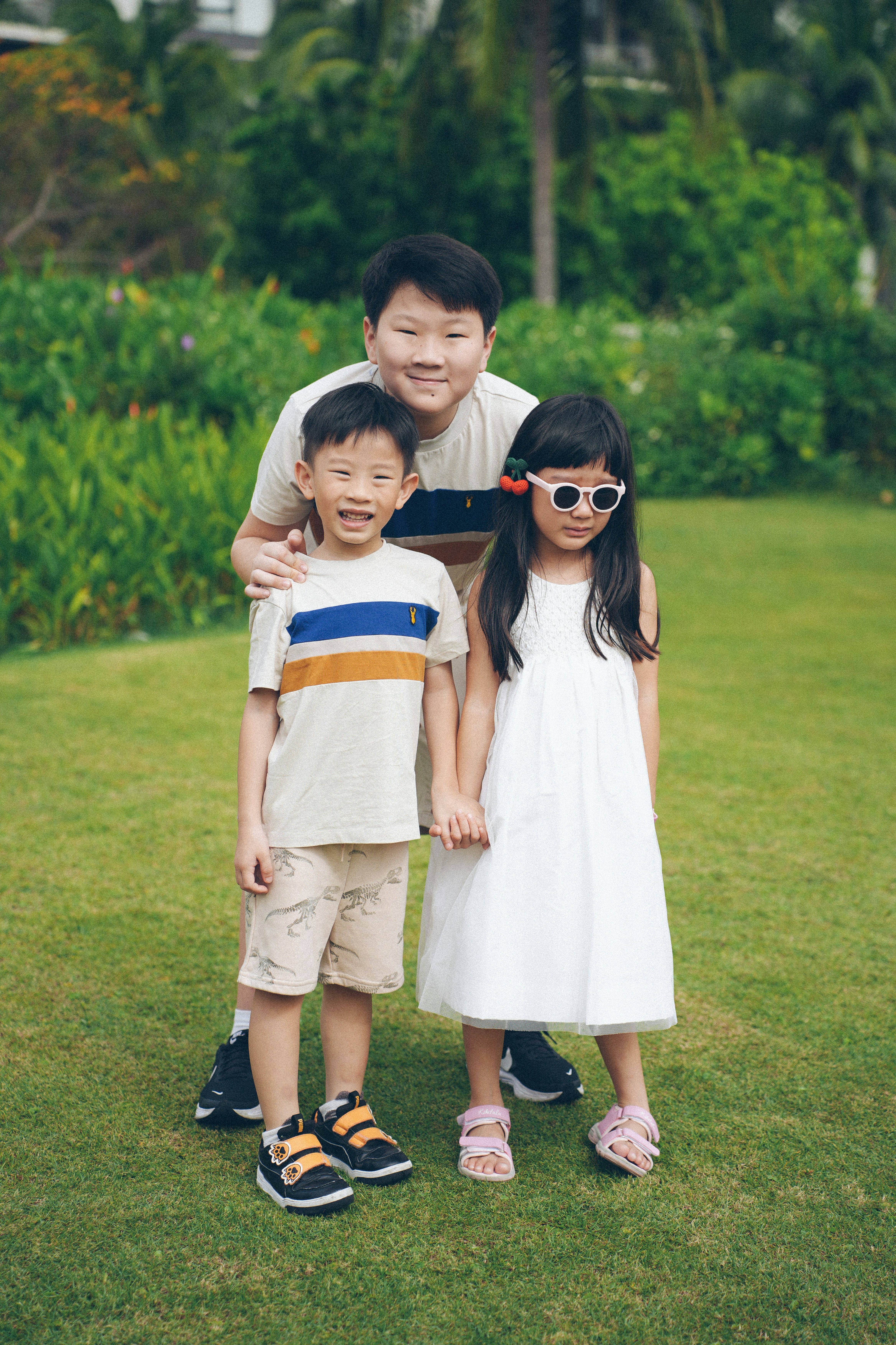 Three in White: A Sunny Group Portrait in the Park