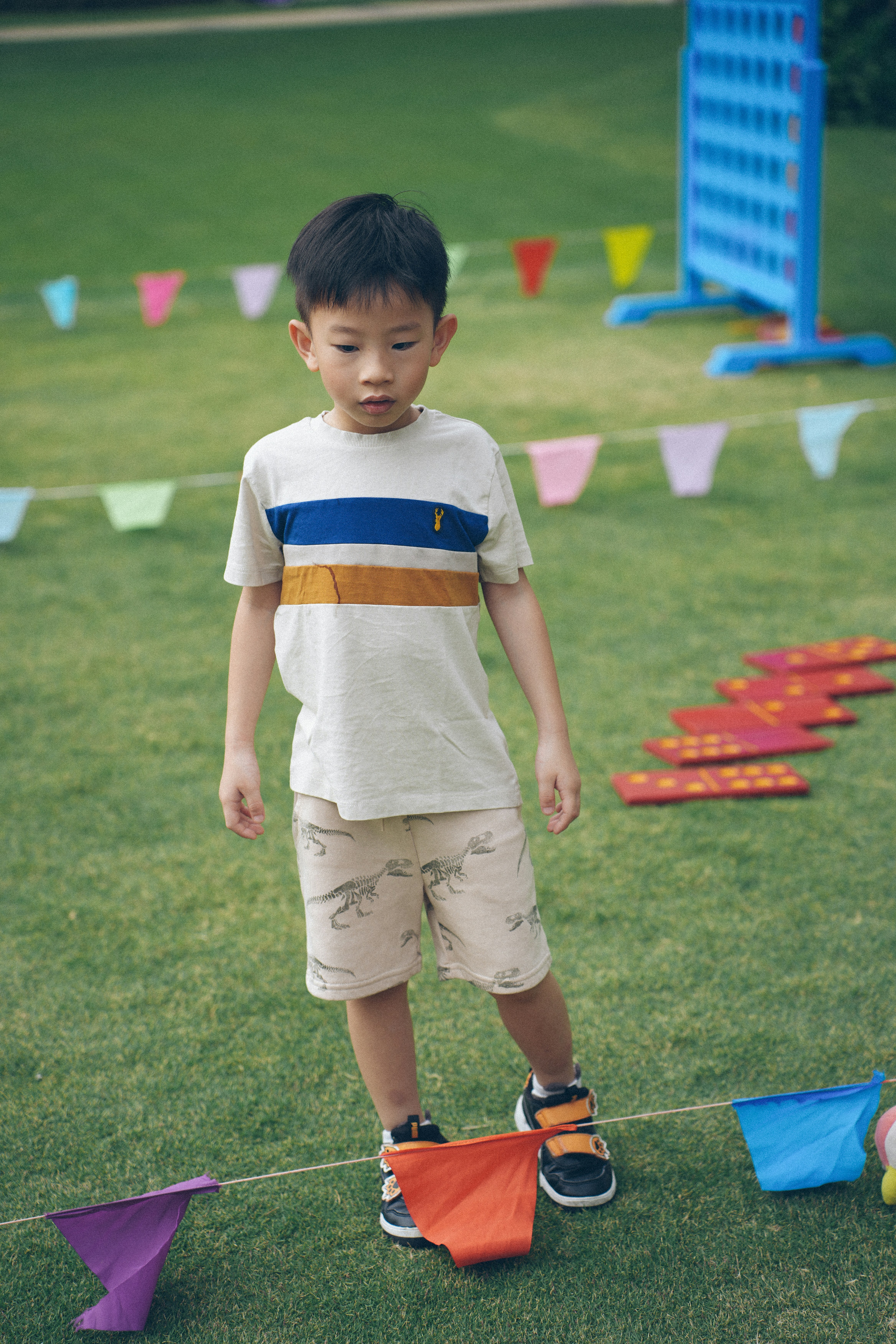 Young field explorer steps carefully through a colorfully marked obstacle course