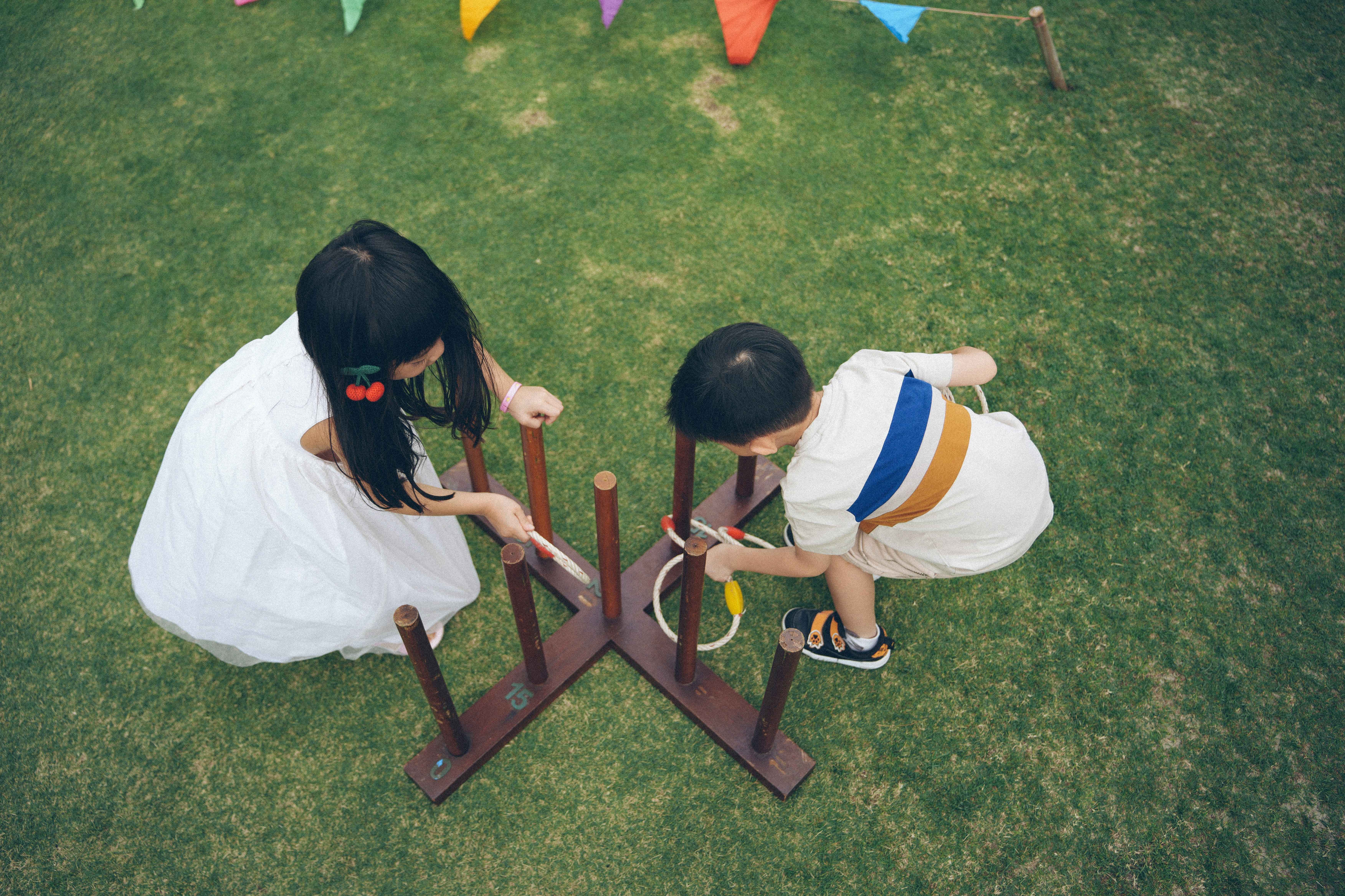 Children at a vintage play centerpiece in a sunlit garden