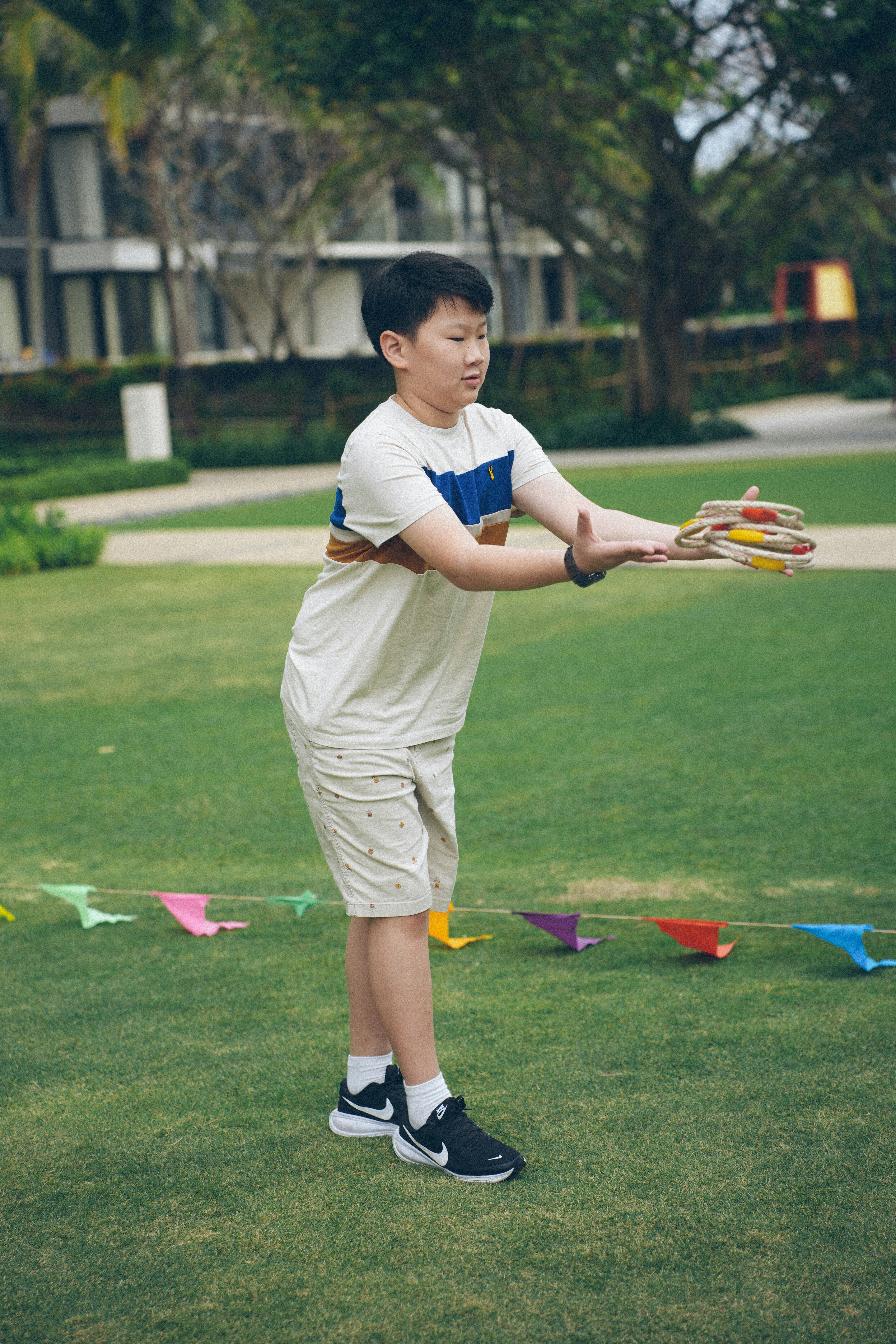 Cross-Field Toss: A Youth Practice Session on Sunlit Turf
