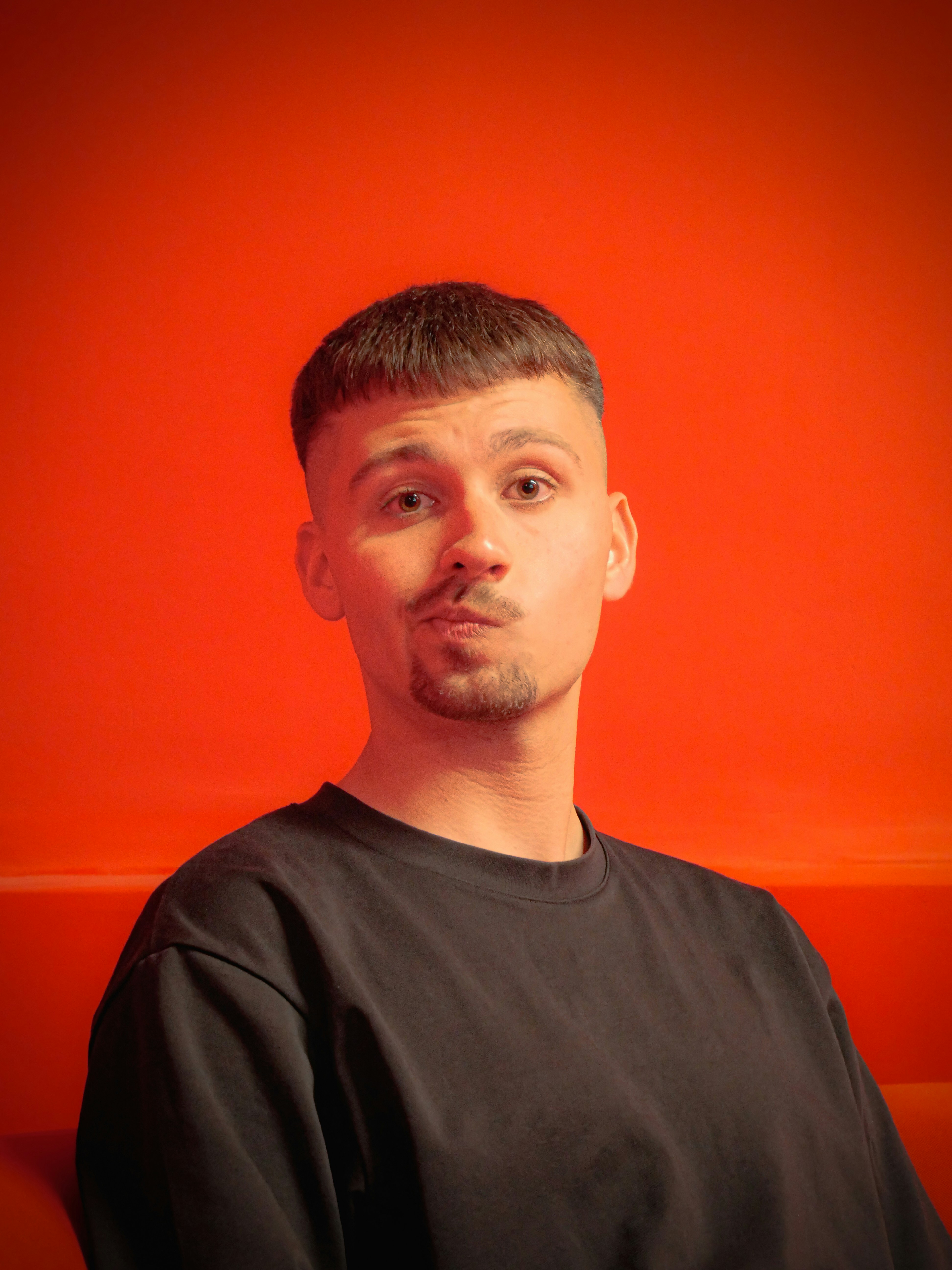 Bold gaze in a crimson studio