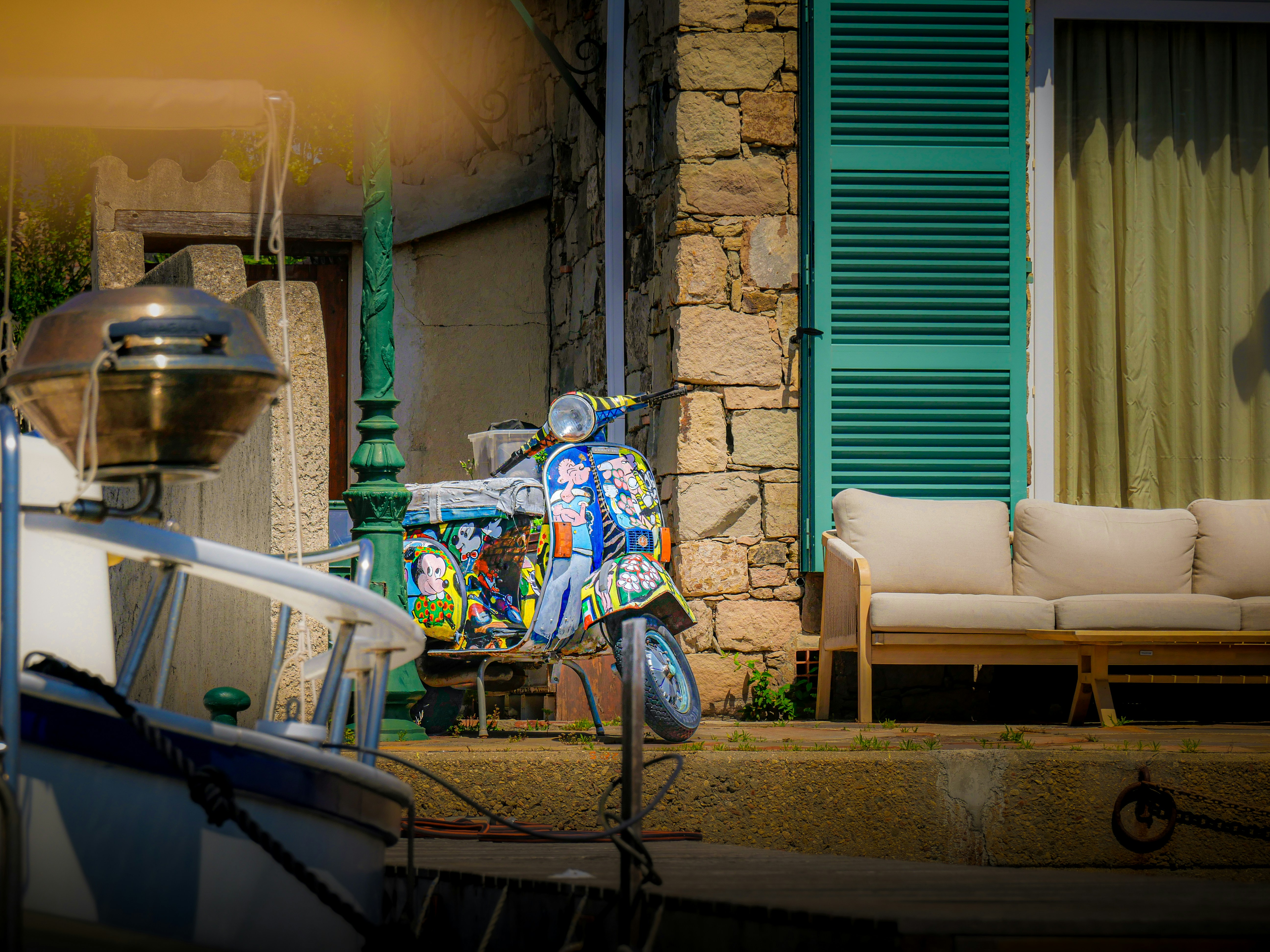 Sunlit Patio by the Scooter: Colorful Charms of a Quiet Corner