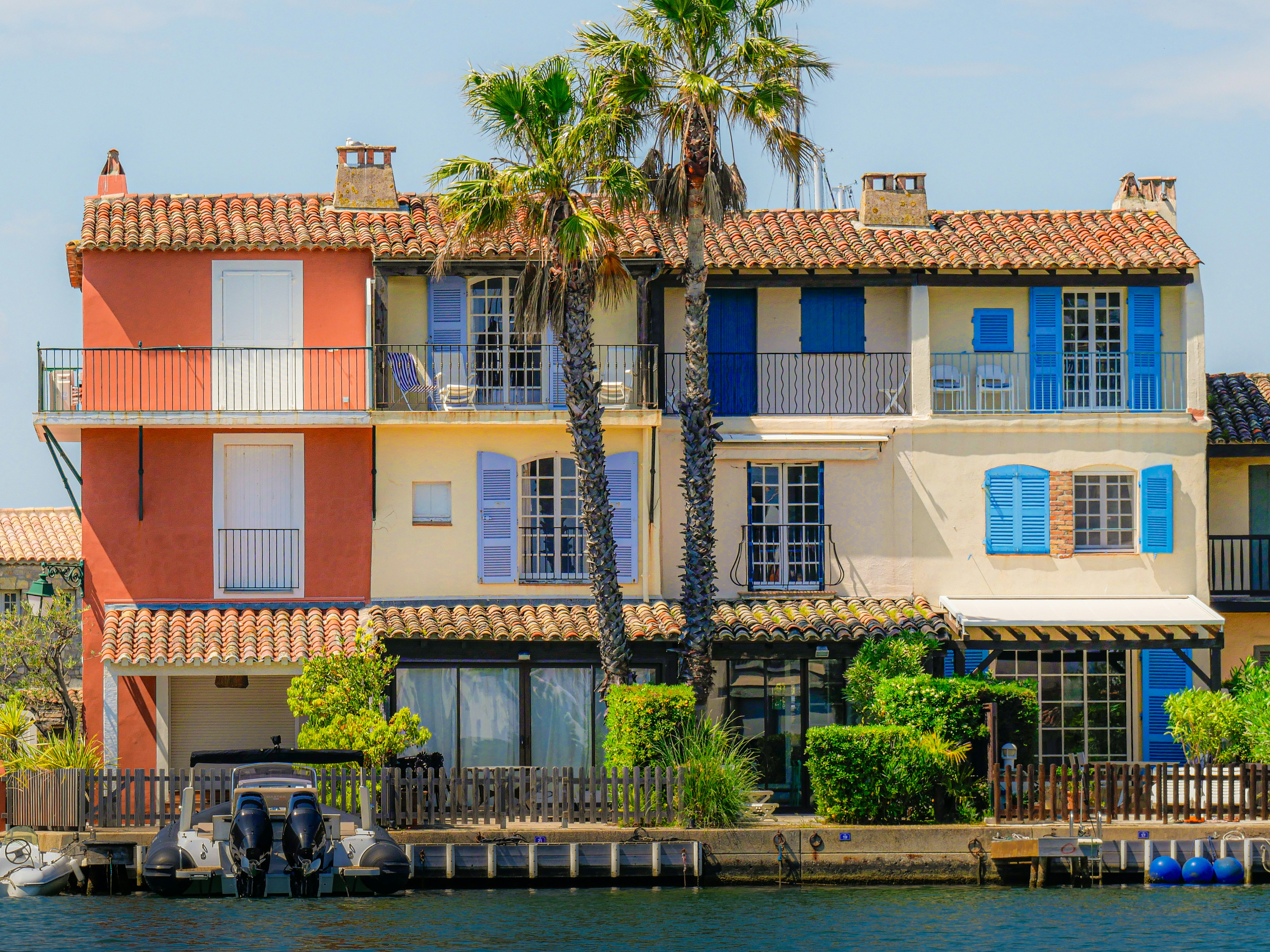 Color-blocked Waterfront Villa: A Sunlit Palette of Palm and Terrace