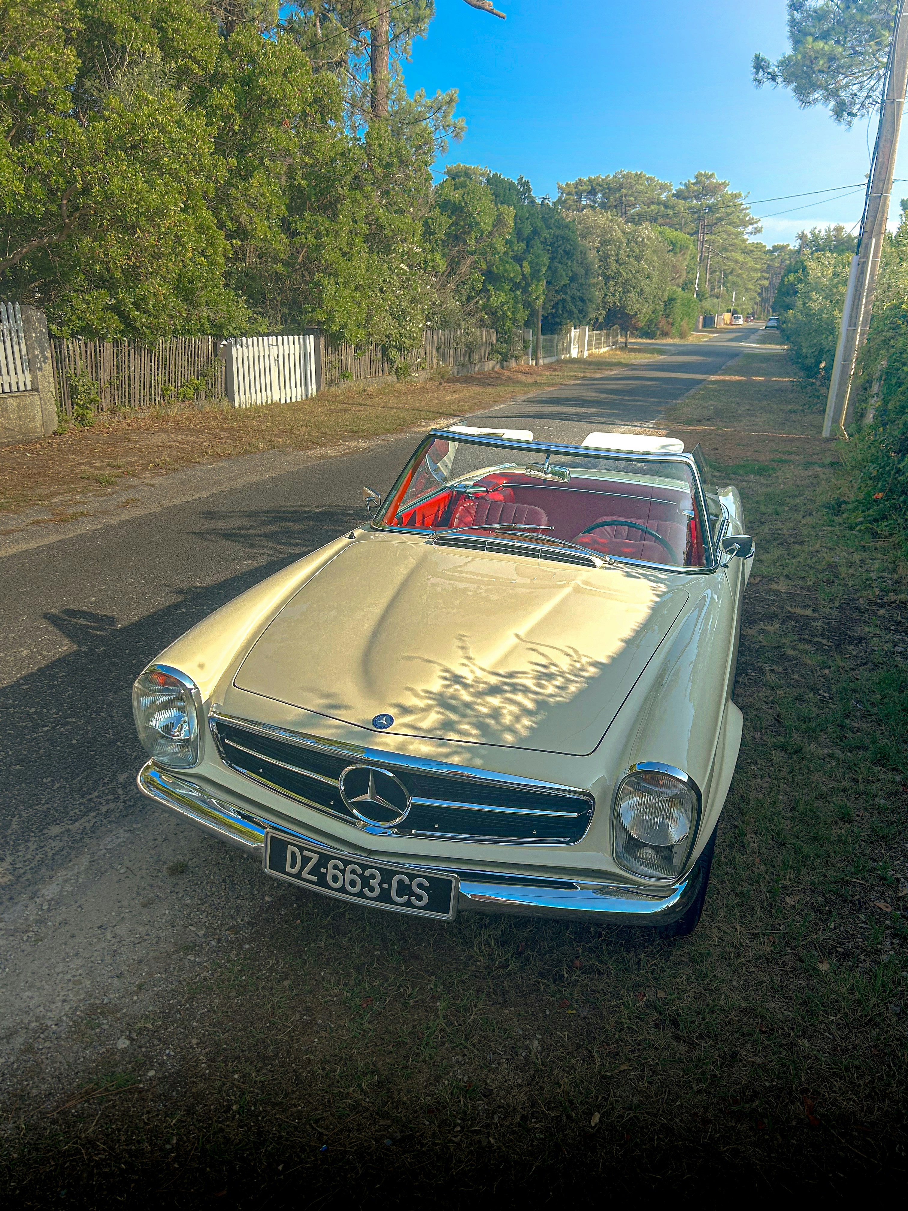Sunlit Mercedes Roadster: Vintage Convertible on a Quiet Country Lane