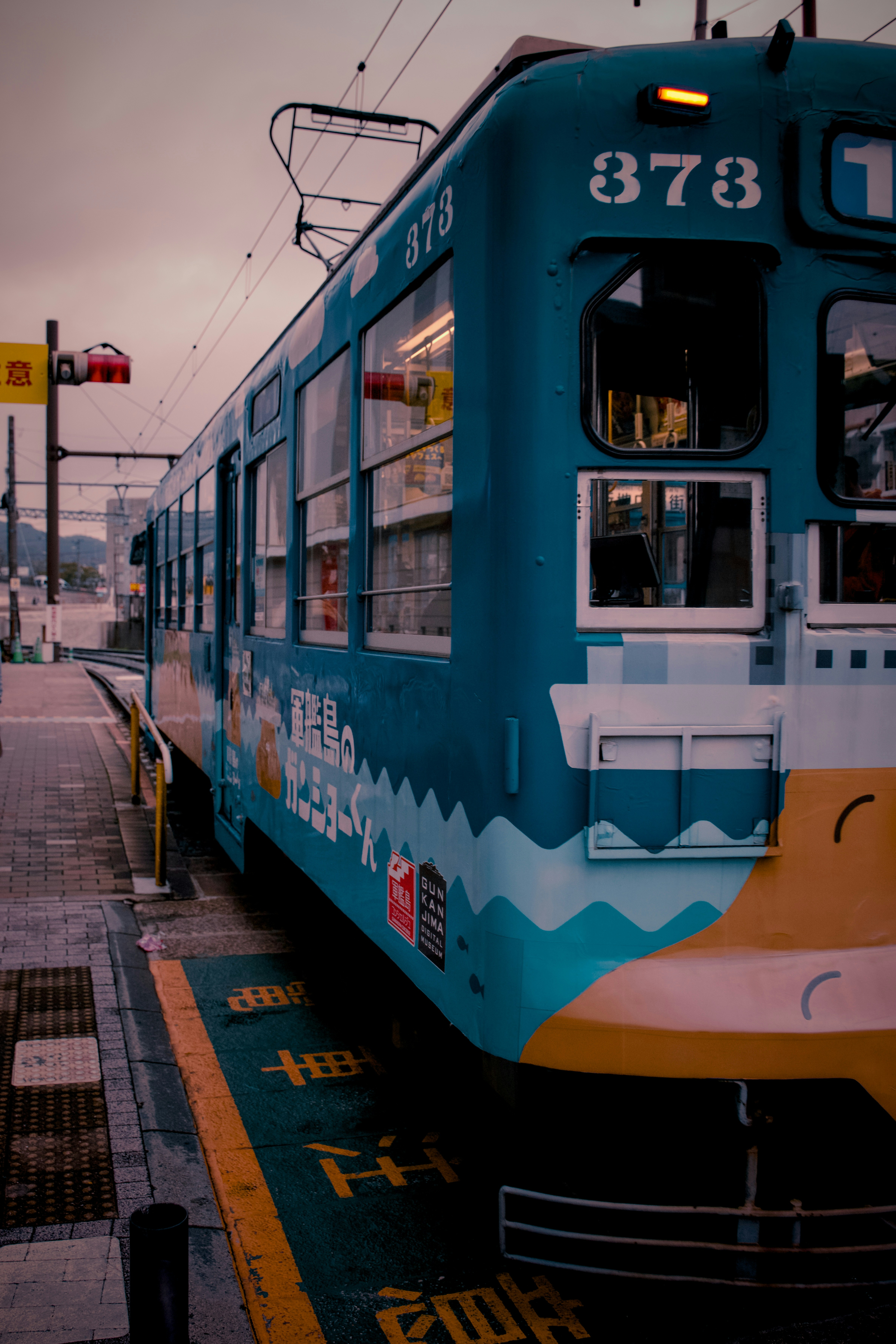 Blue Tram at Dusk: A Coastal Platform’s Quiet Boldness