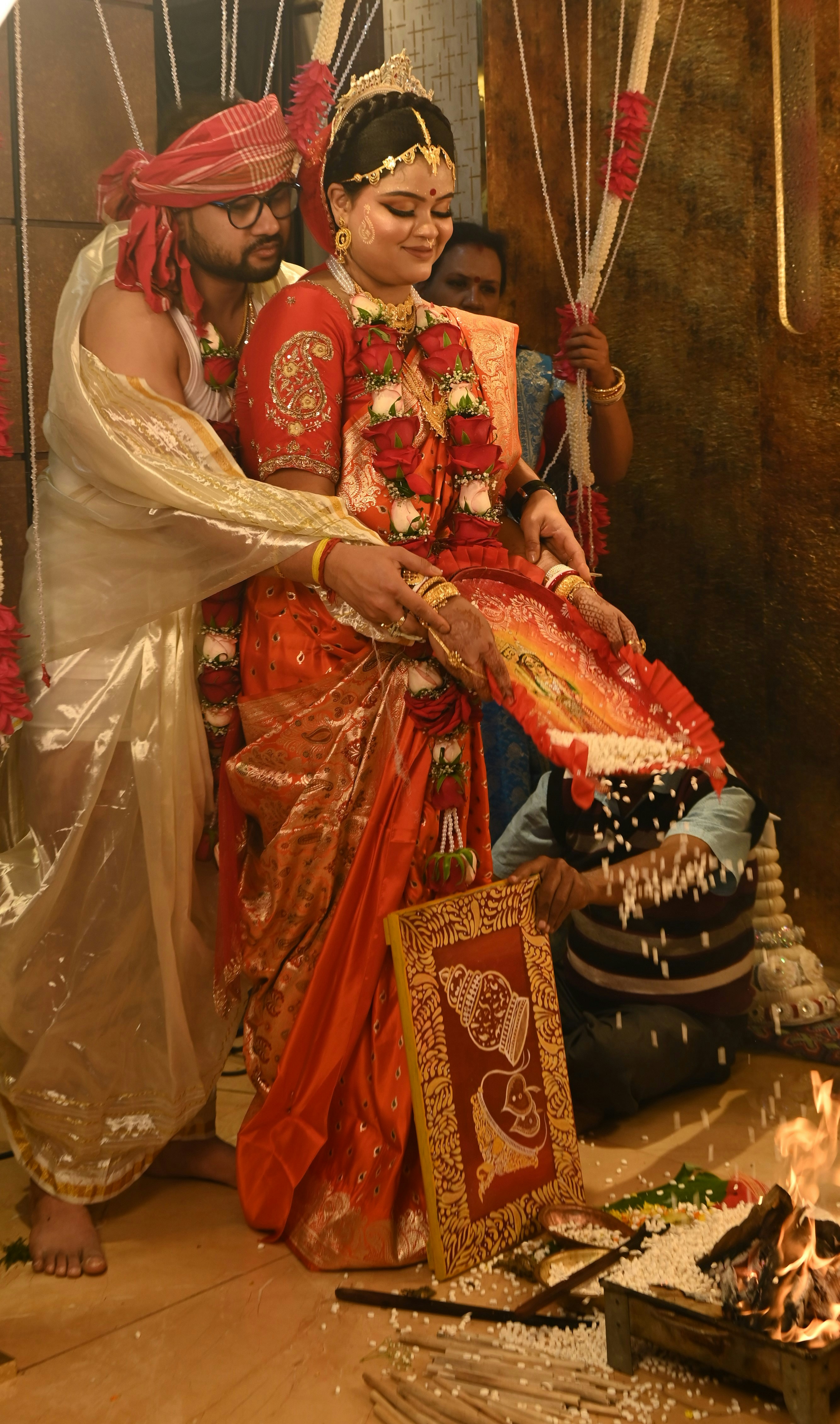 Graceful Bride in Orange: A Moment of Ceremony Under Floral Trellis