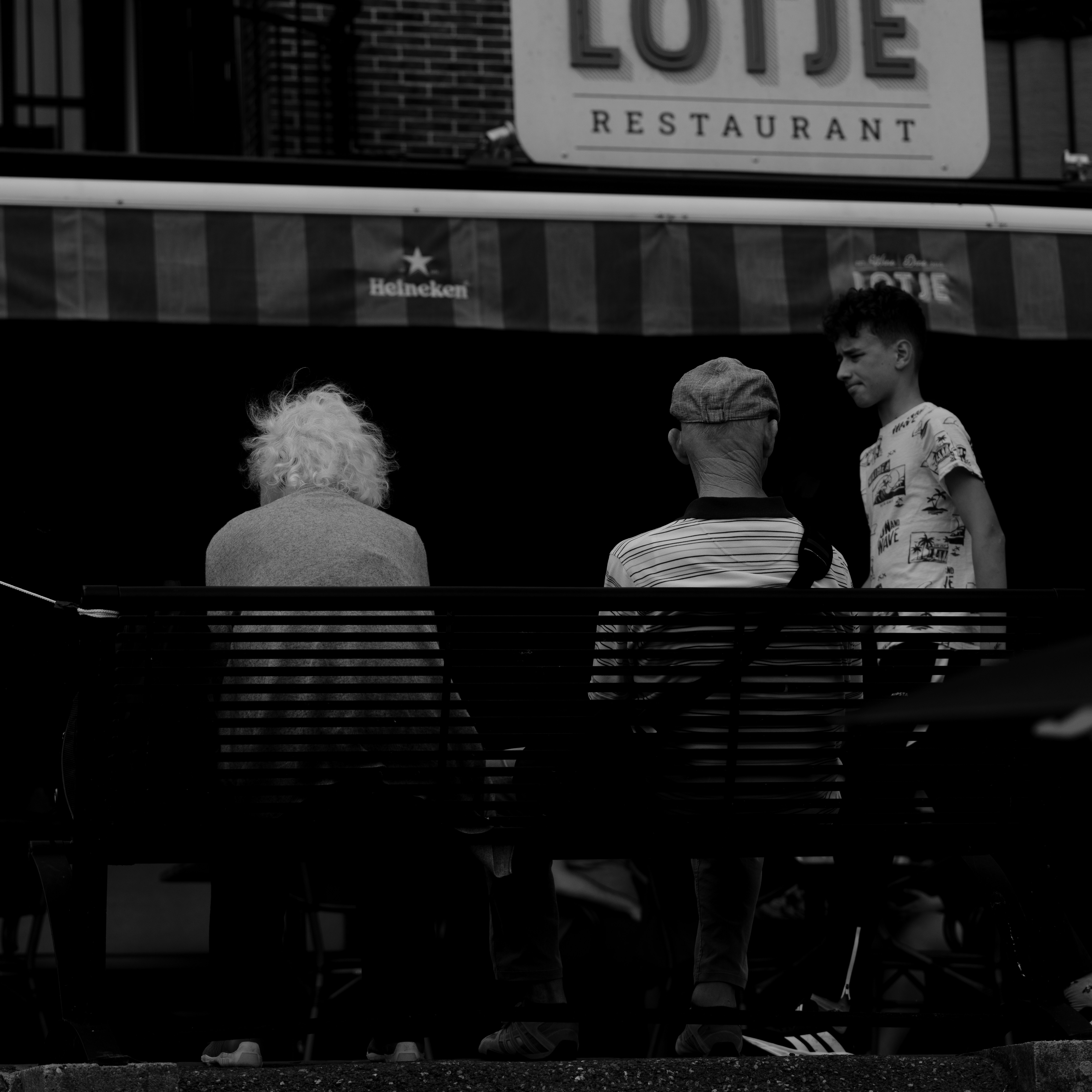 Night at the Lote: Stack of Conversation on a Dim Café Balcony