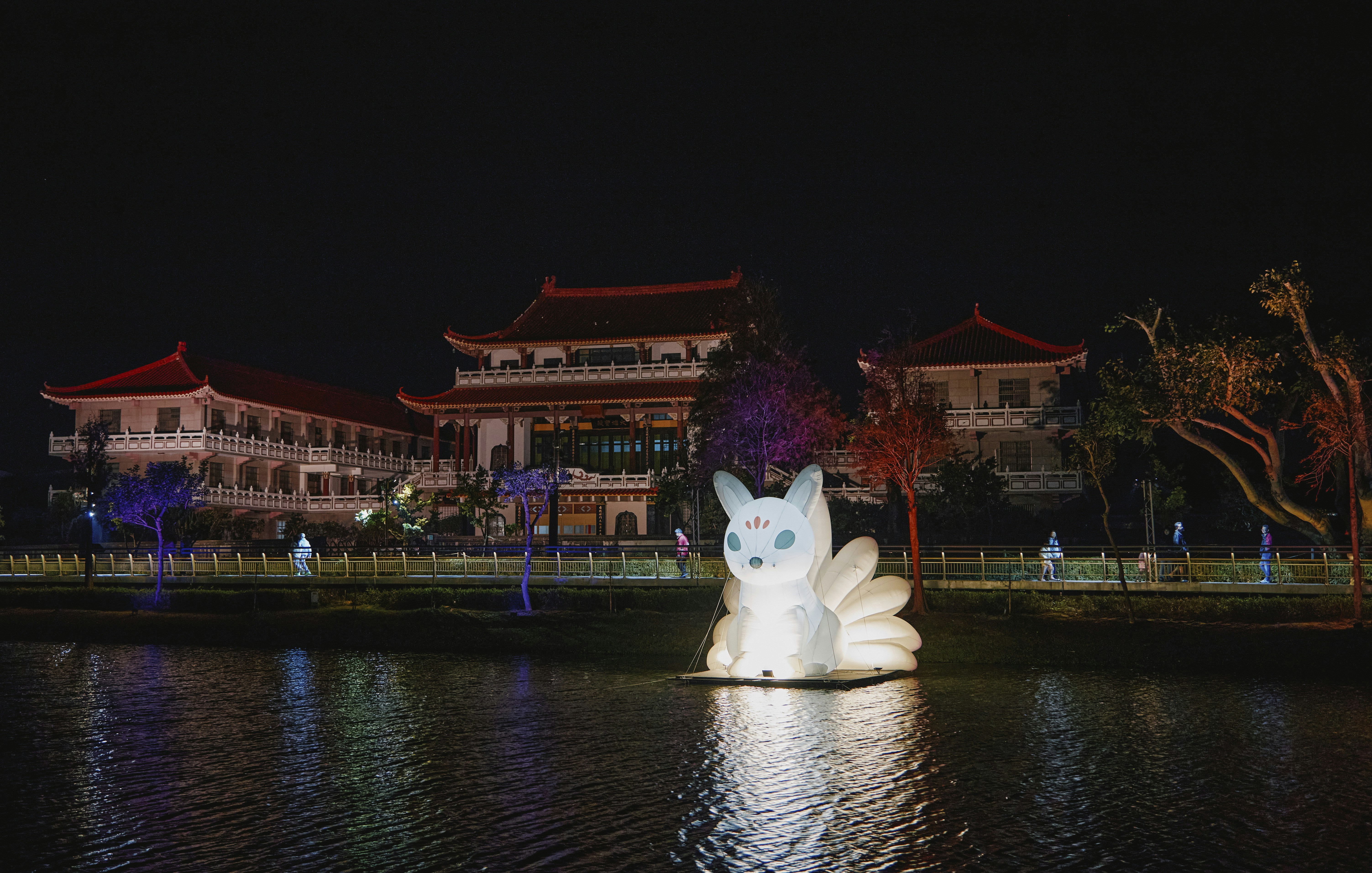 Glow in the Lake: A Lit Bunny Floats by Moonlit Temples