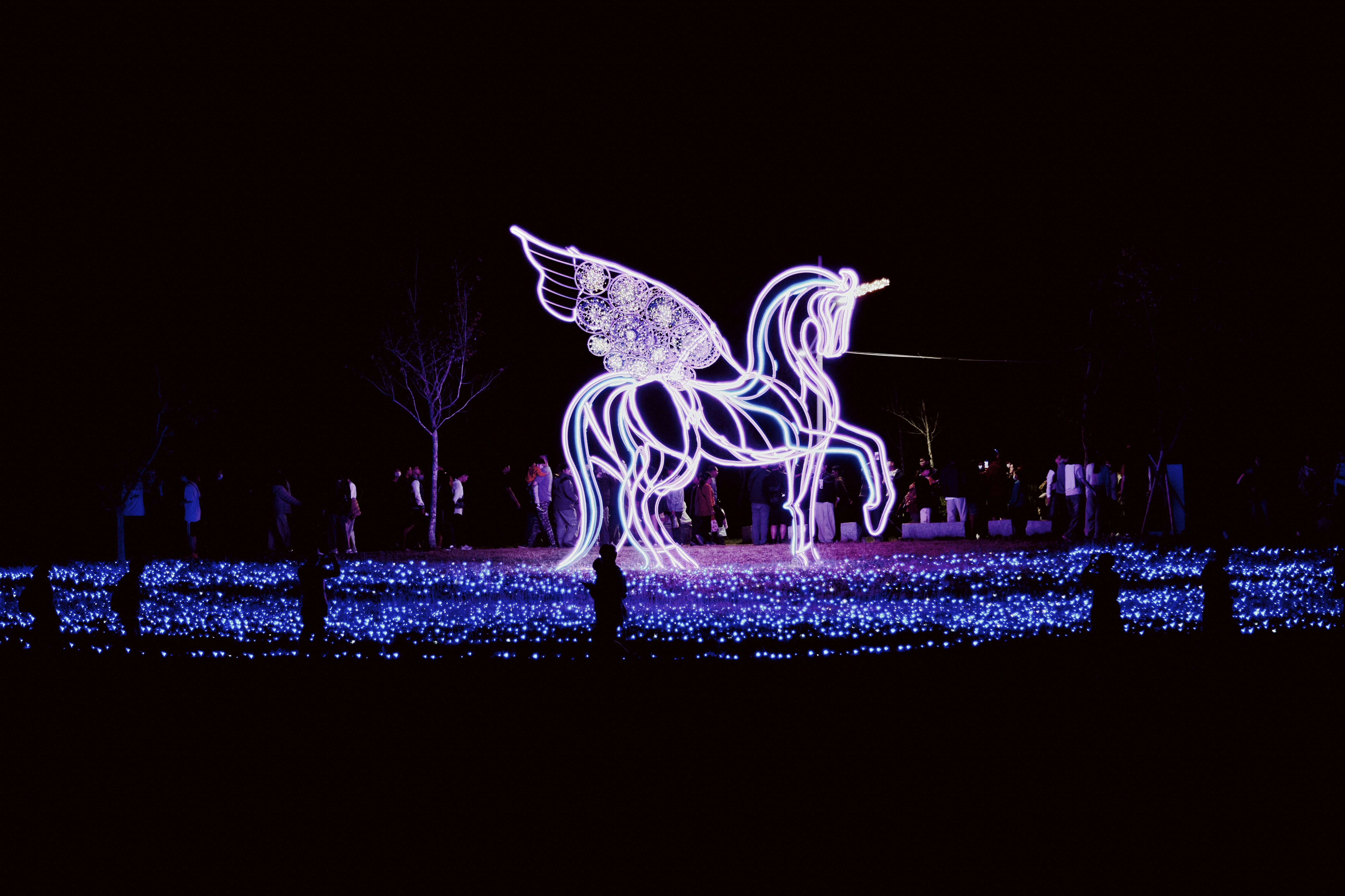 Luminous Pegasus Beneath a Night Sky of Blue Fireflies