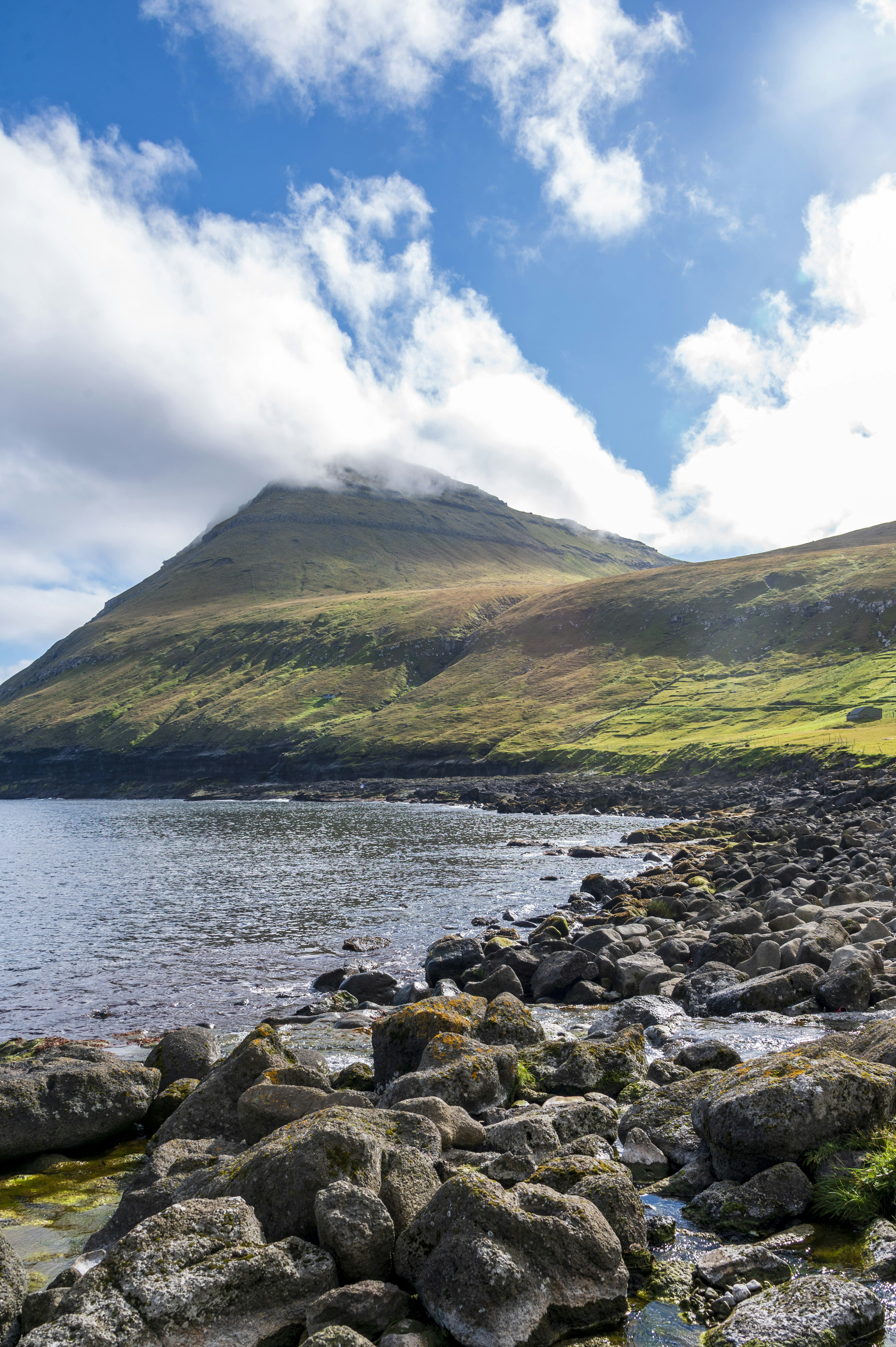 Cloud-Top Summit Over a Shattered Shore