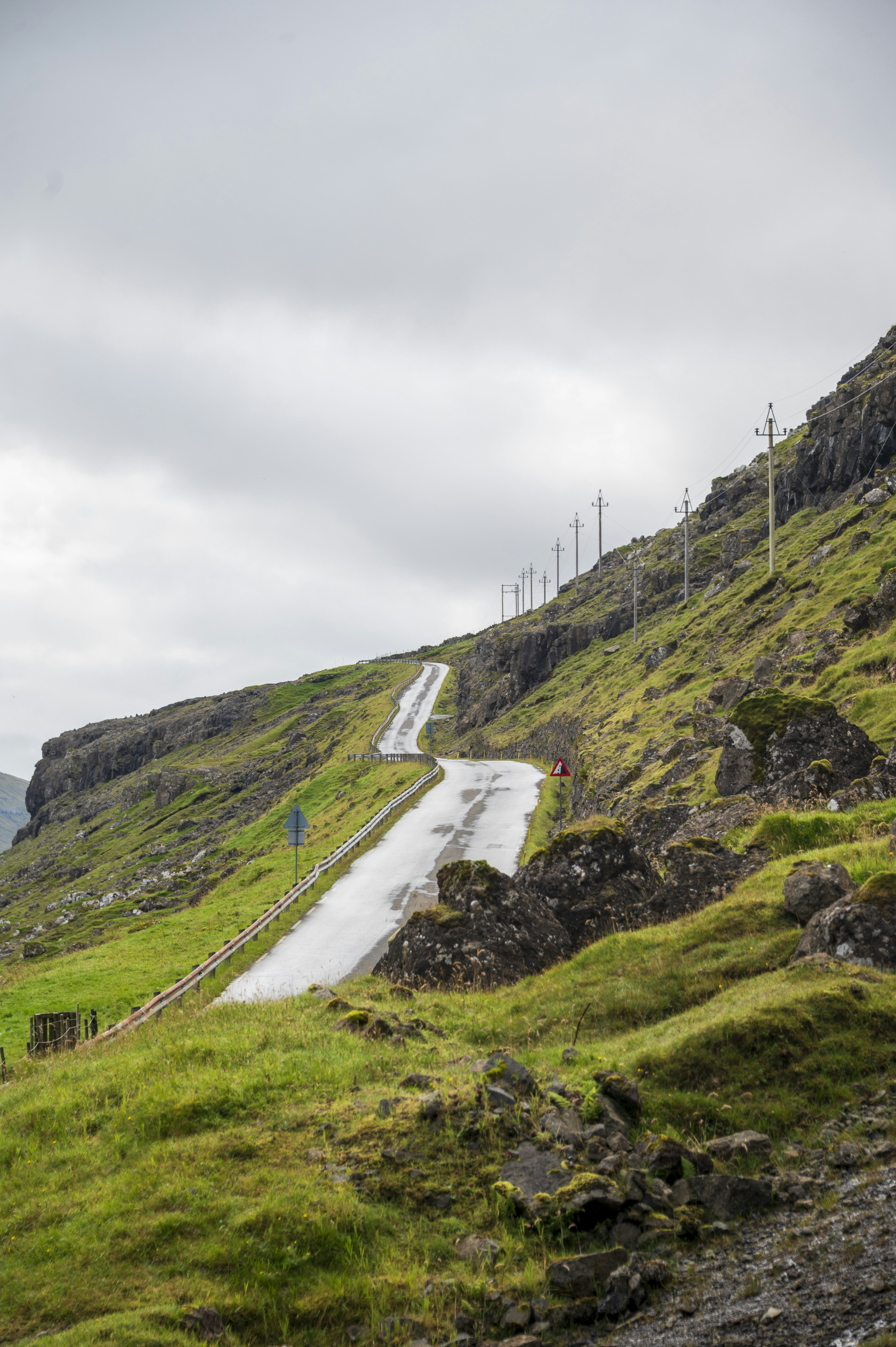 A Winding Highland Road Carves Through Rugged Green Slopes