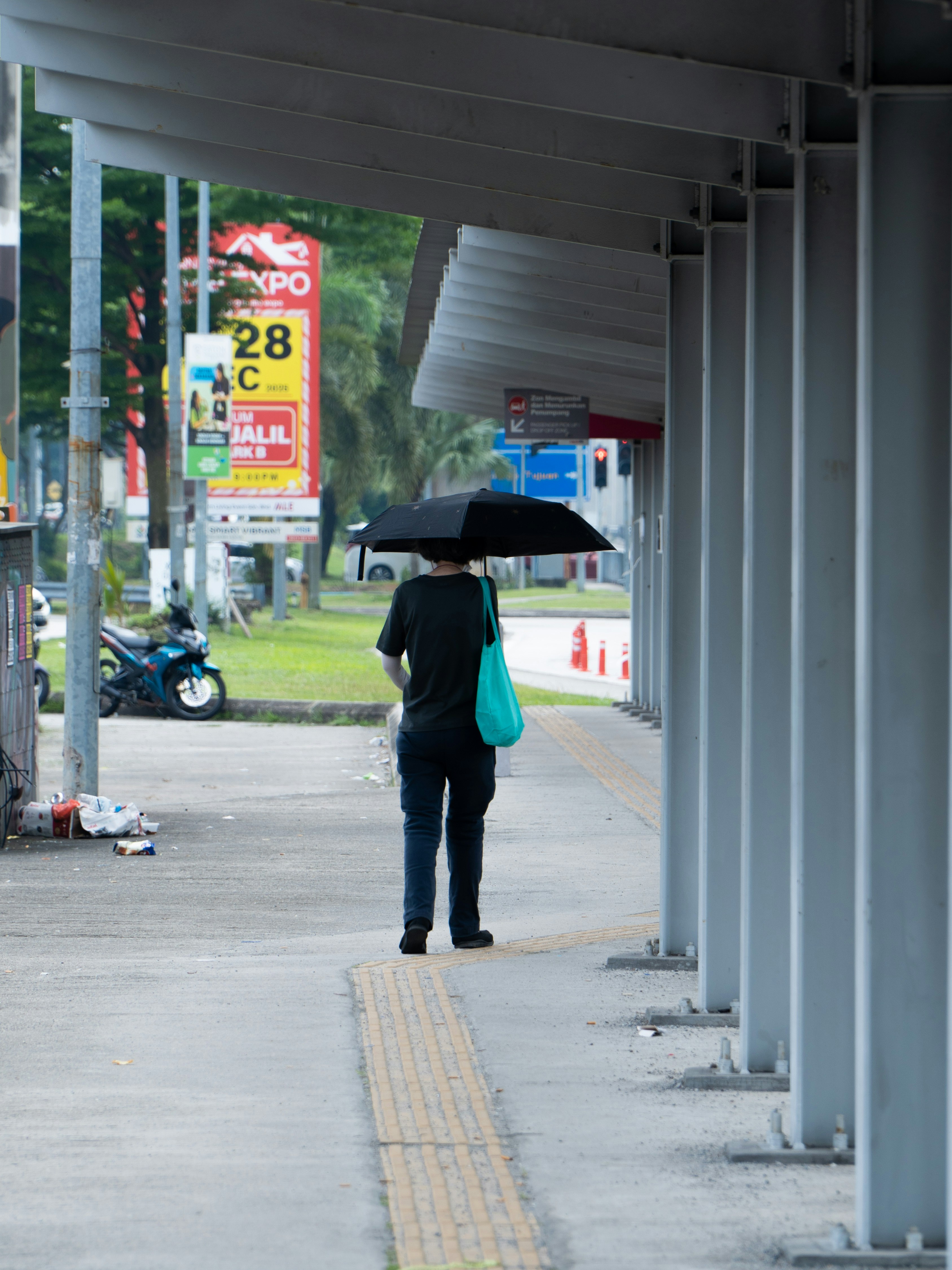 Umbrella Rider in a Covered Walkway
