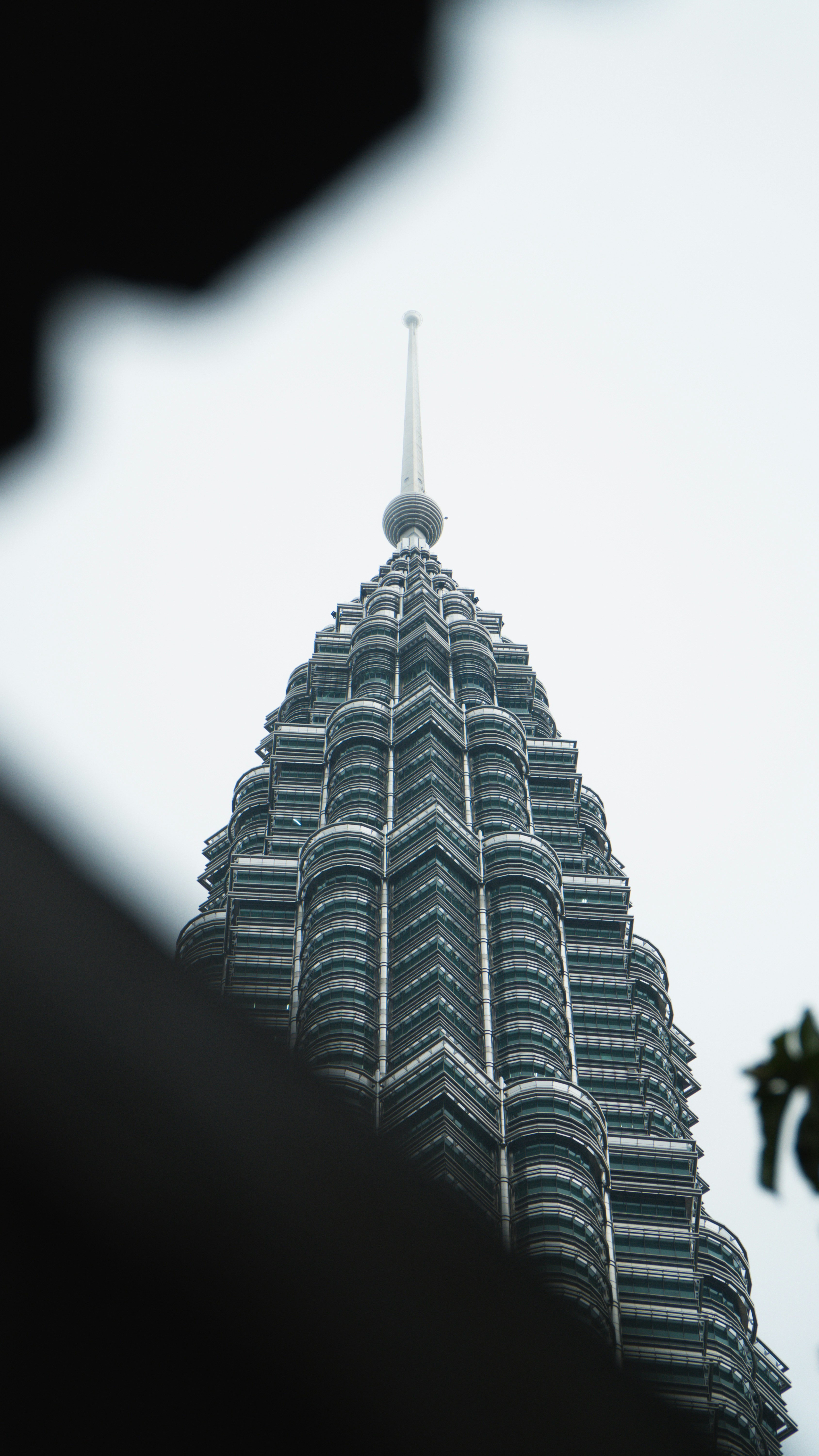 Chasing Concrete Spires: The Petronas Tower Emerges Through Framing Shadows