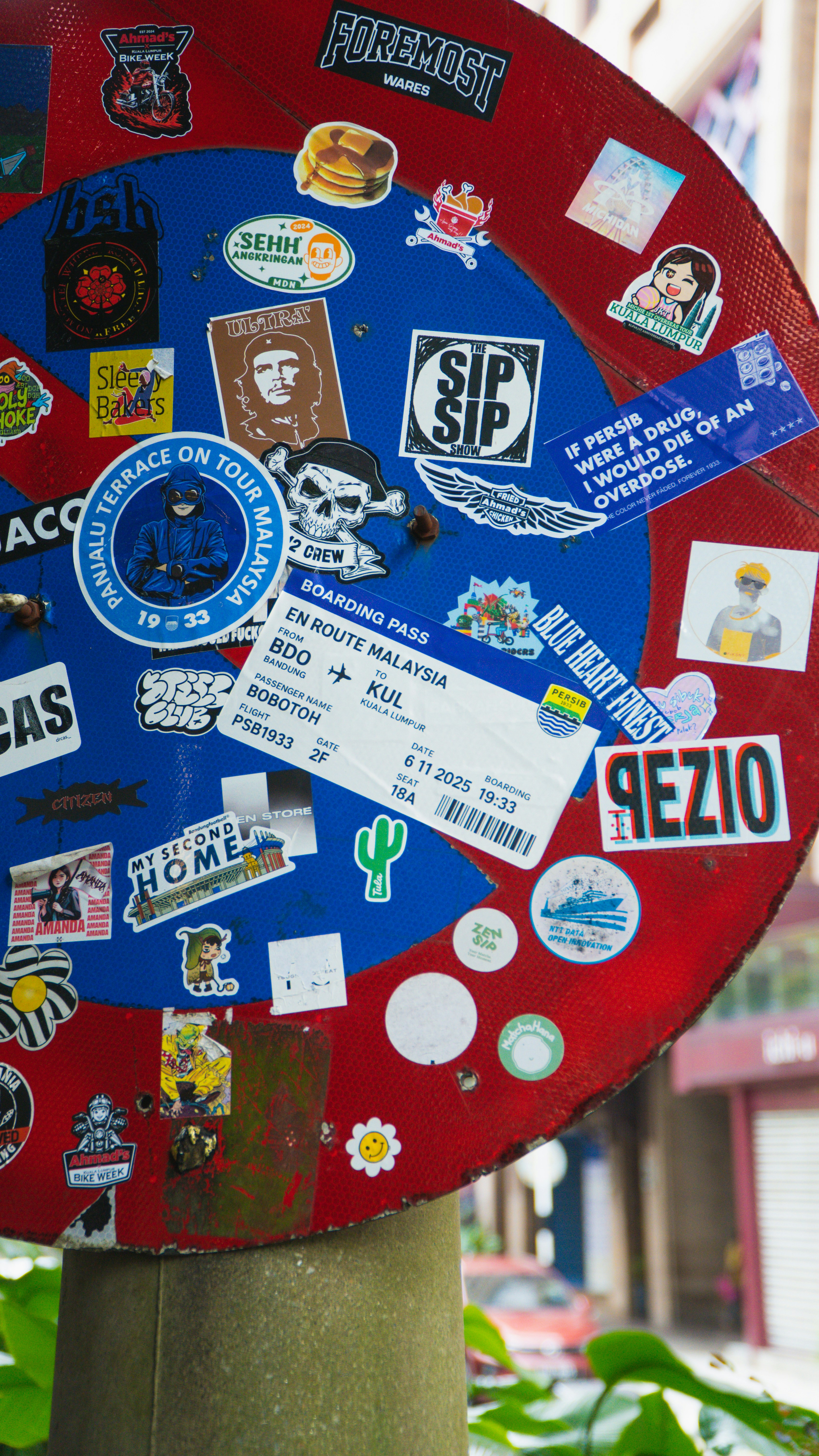 Sticker Mosaic on a Red Circular Sign