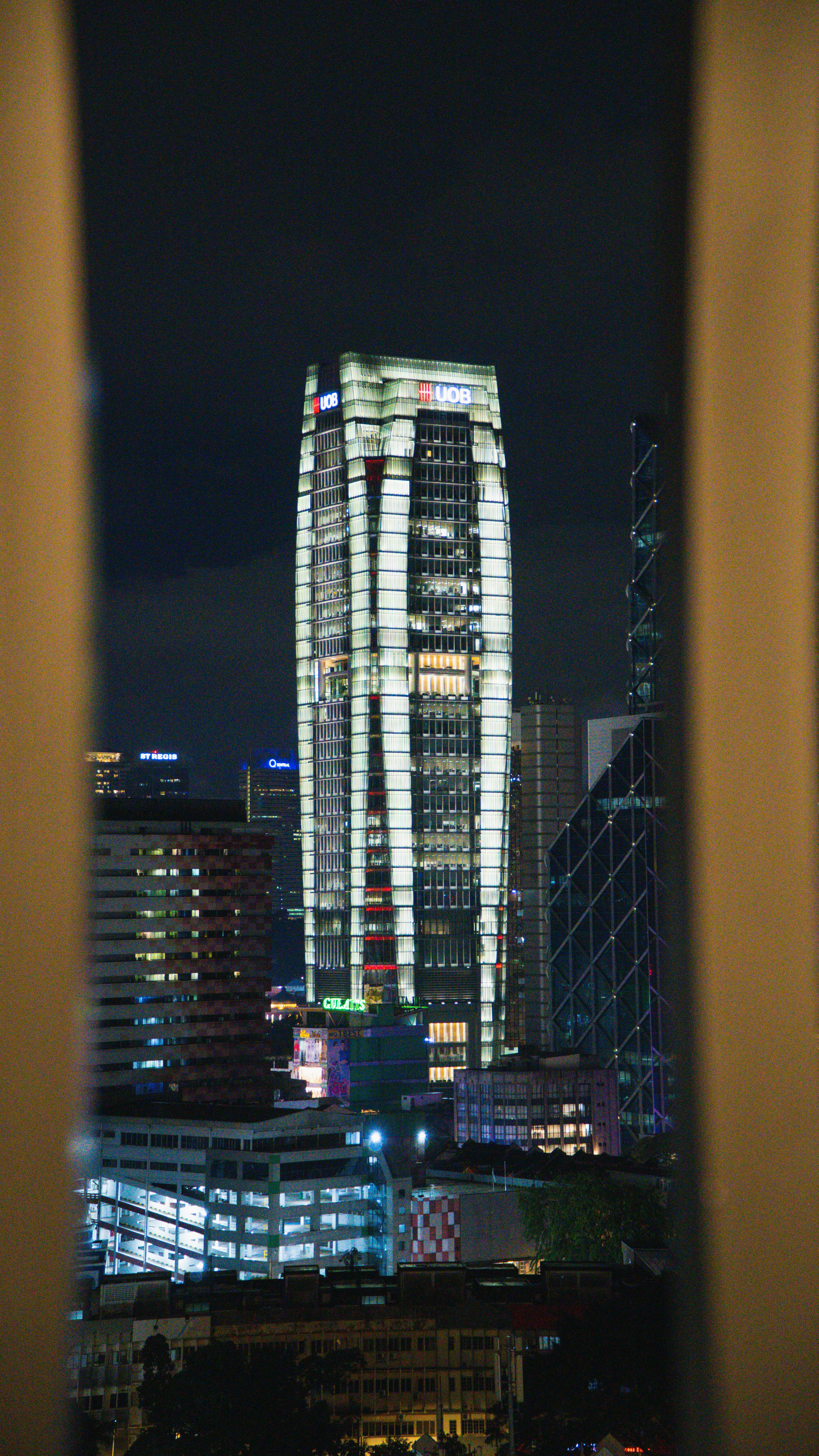 Midnight Skyline Framed by Balcony Columns