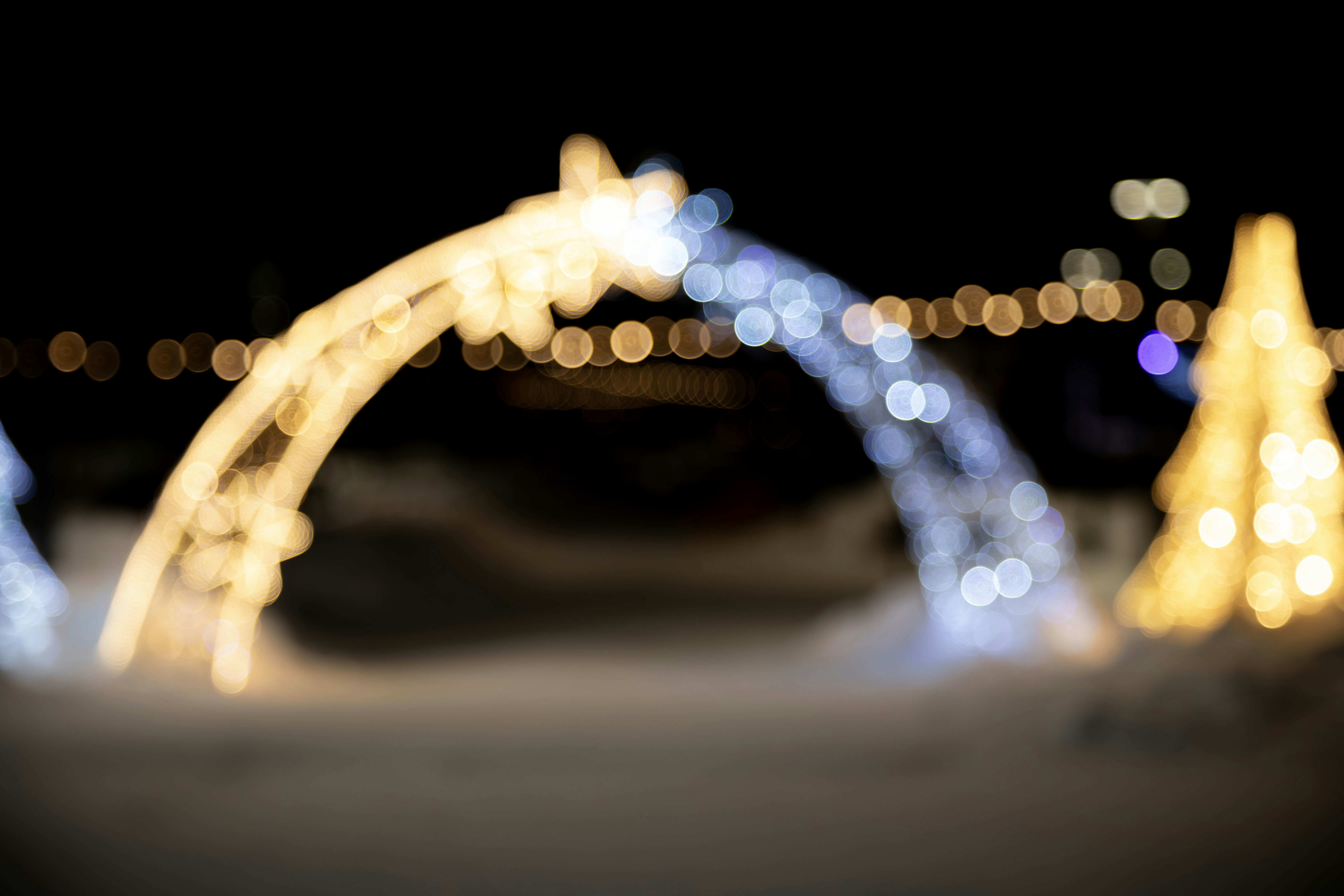 Amber Arc at Night: Blurred Holiday Lights on a Snowy Scene