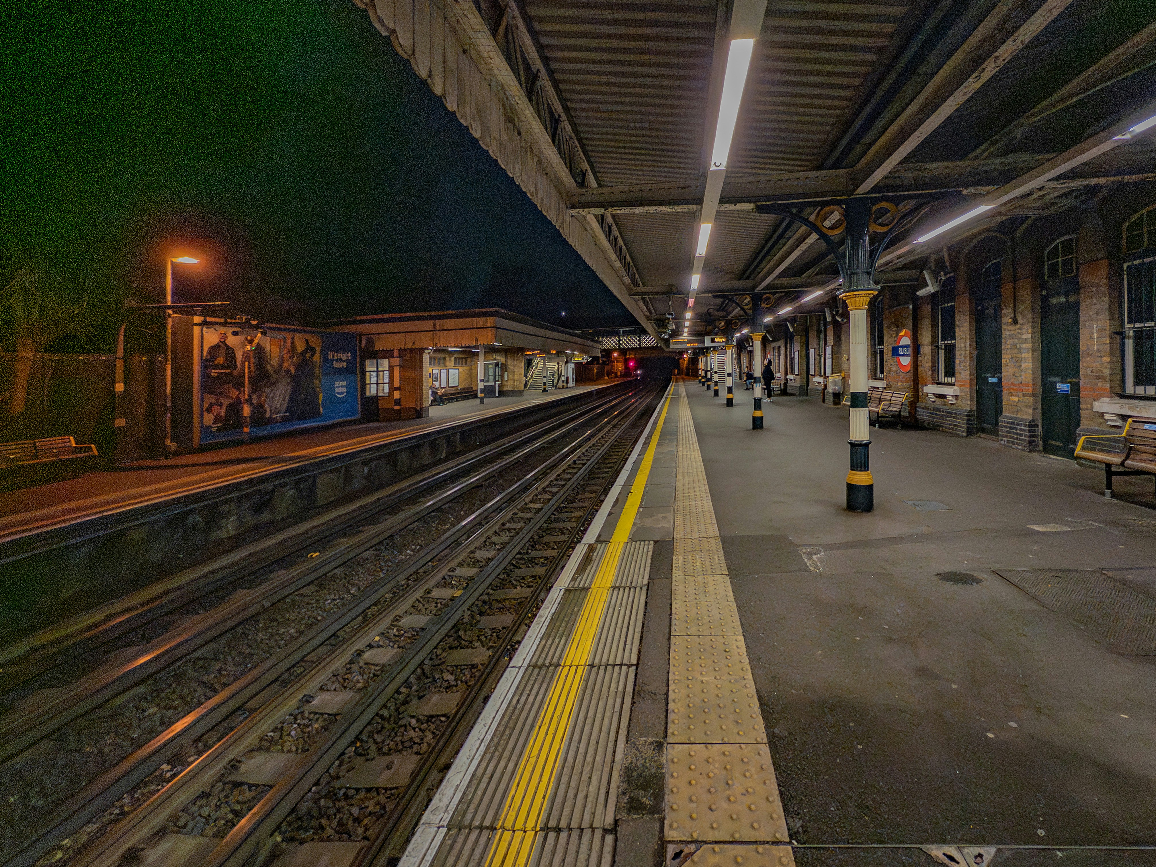 Deserted Platform at Night: Tracks Vanish into the Darkness