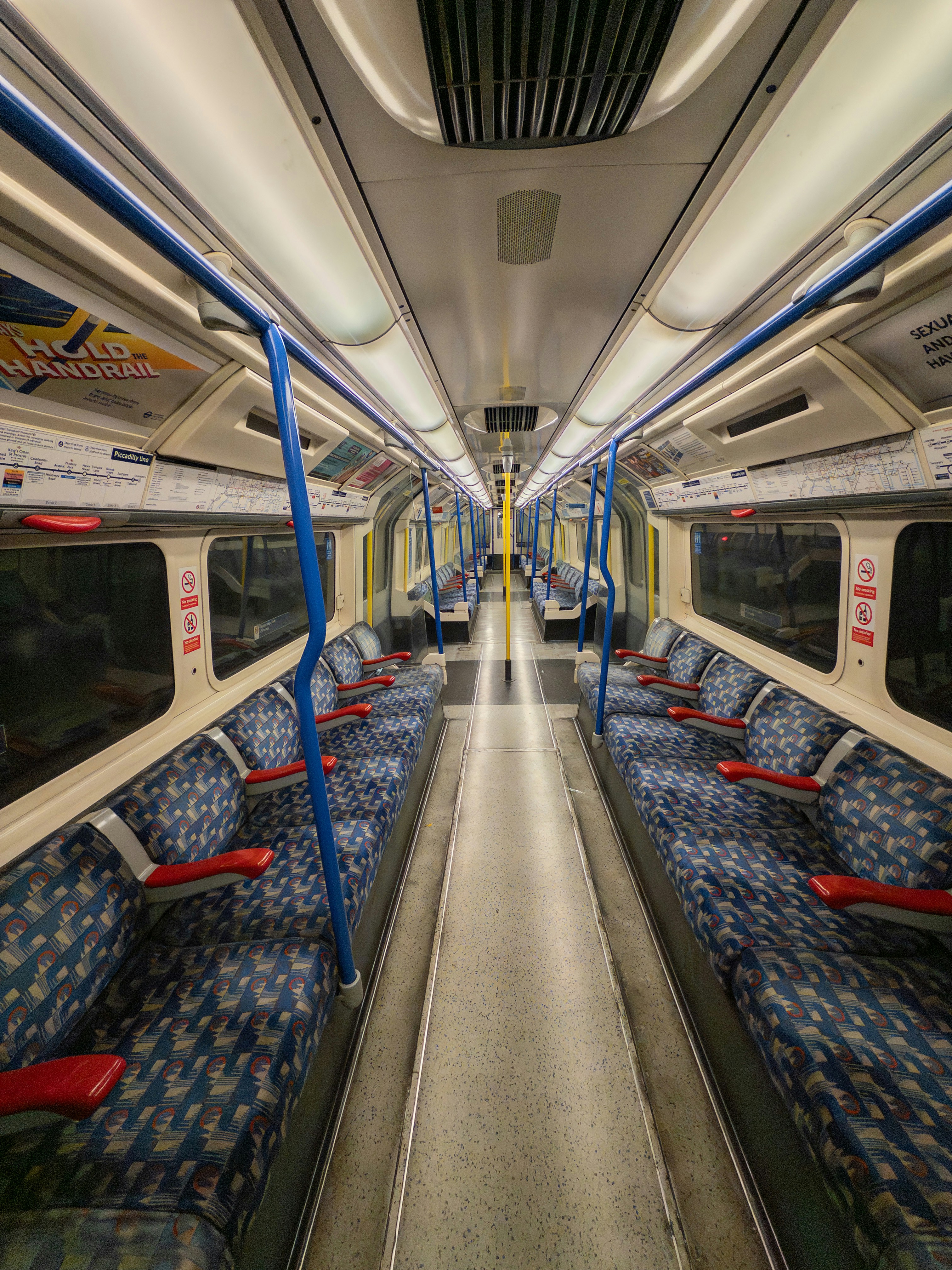 Symmetrical Aisle of Transit: Empty Carriage Vanishing to the Distance