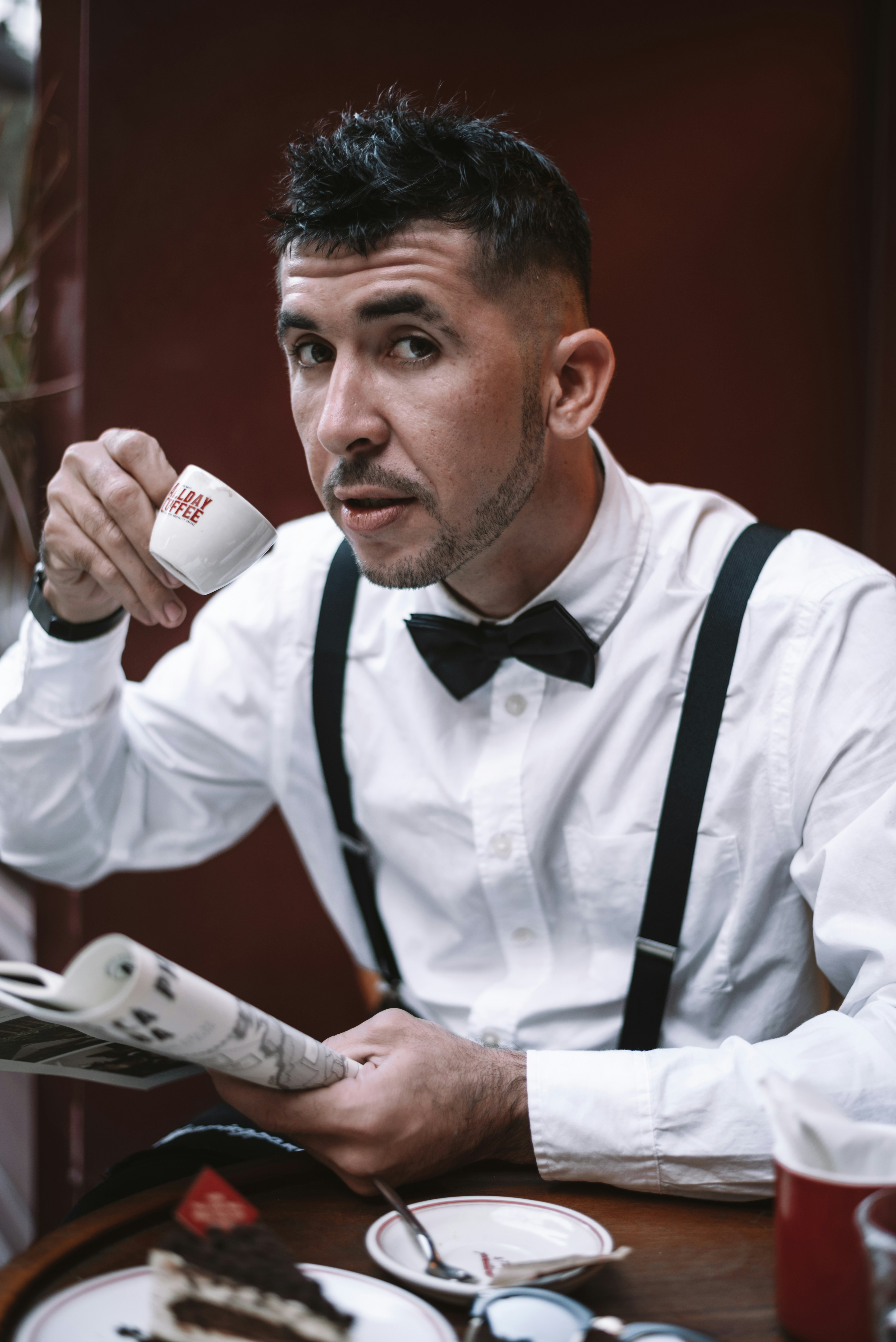 Espresso and Elegance: A Handsome Barista Pauses with a Cup