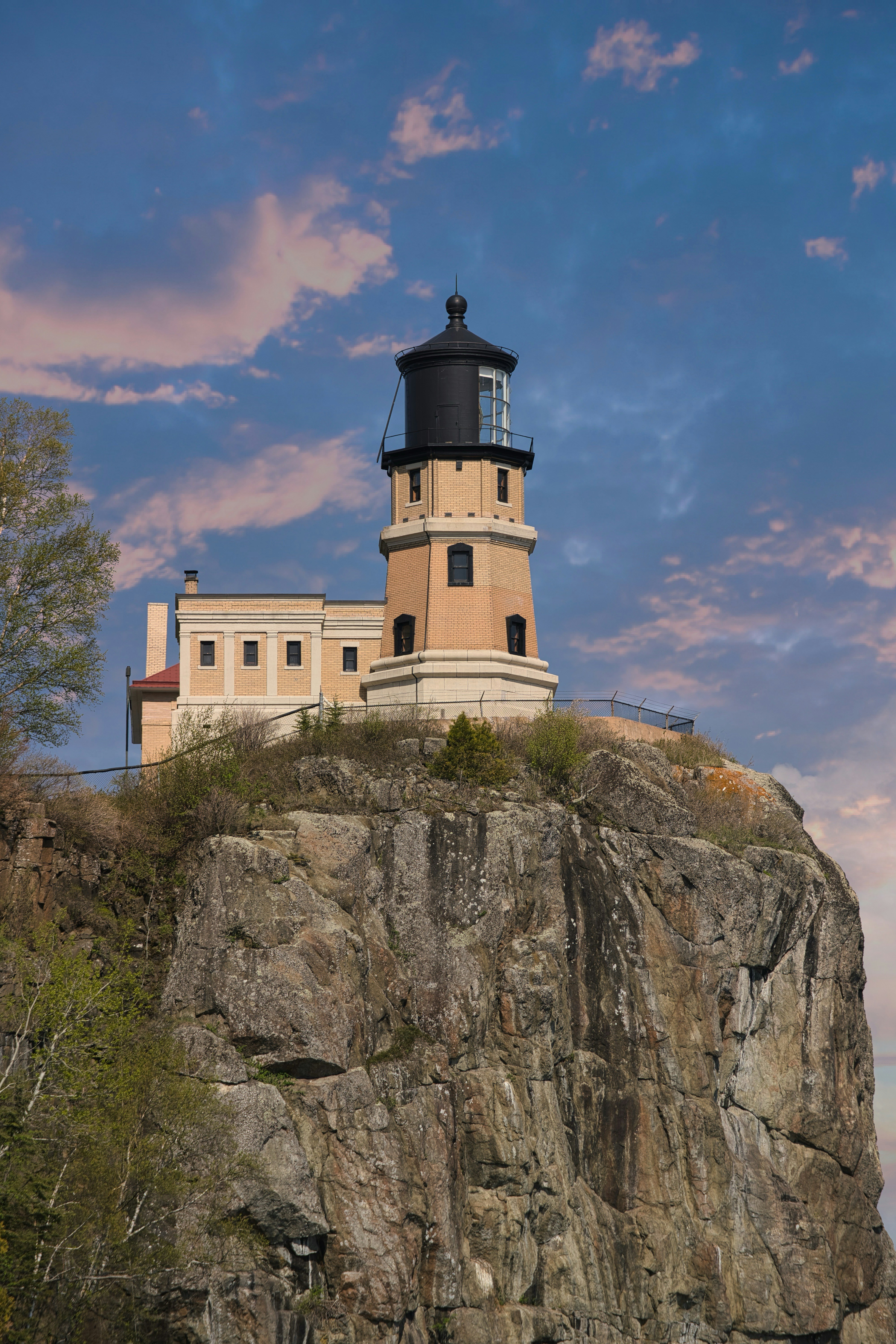 Lighthouse Crowned on a Cliff: A Quiet Sentinel Over the Rocks
