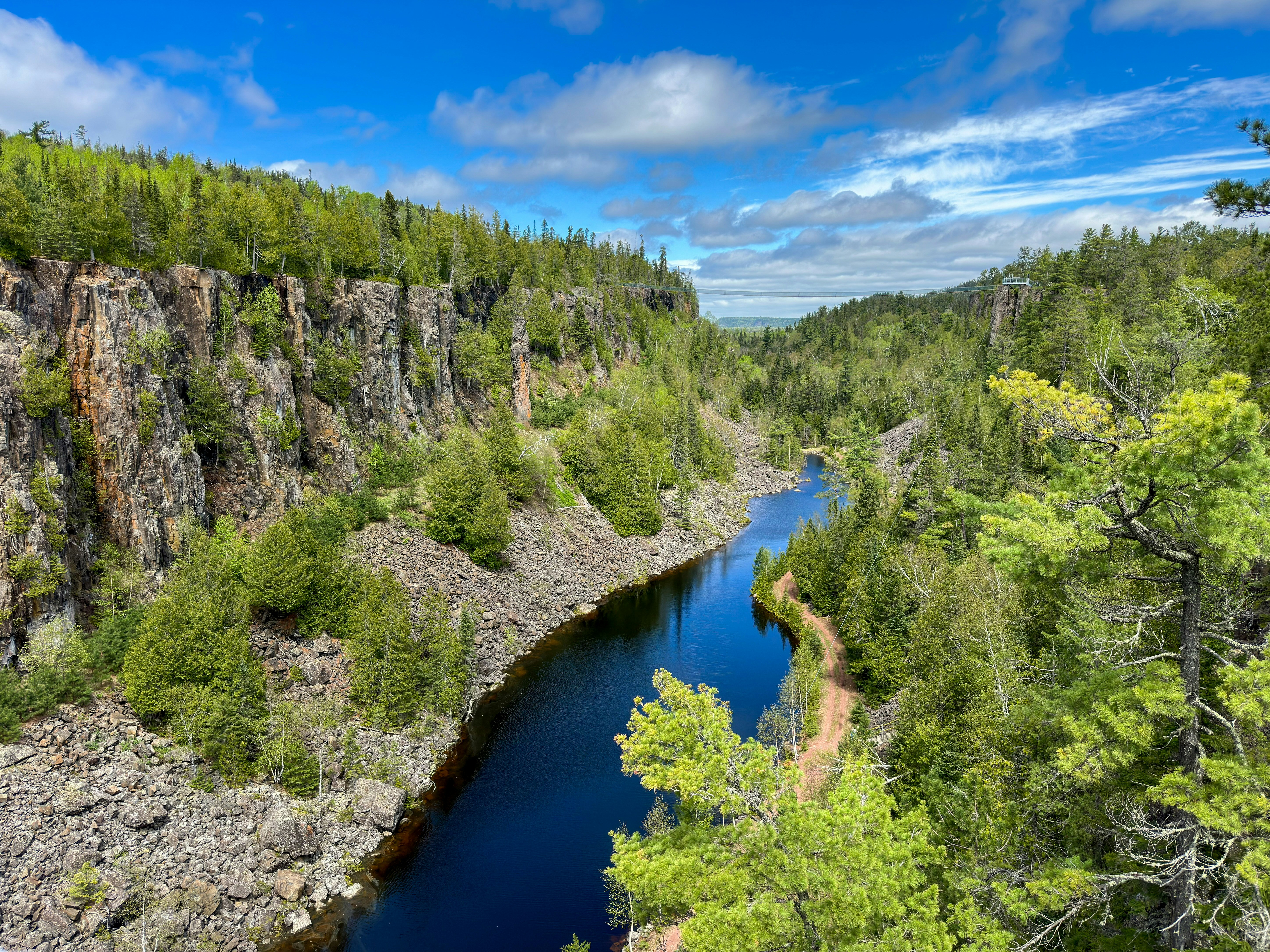 River Gorge under a Sky of Blue: A High-Contrast Canyon Road