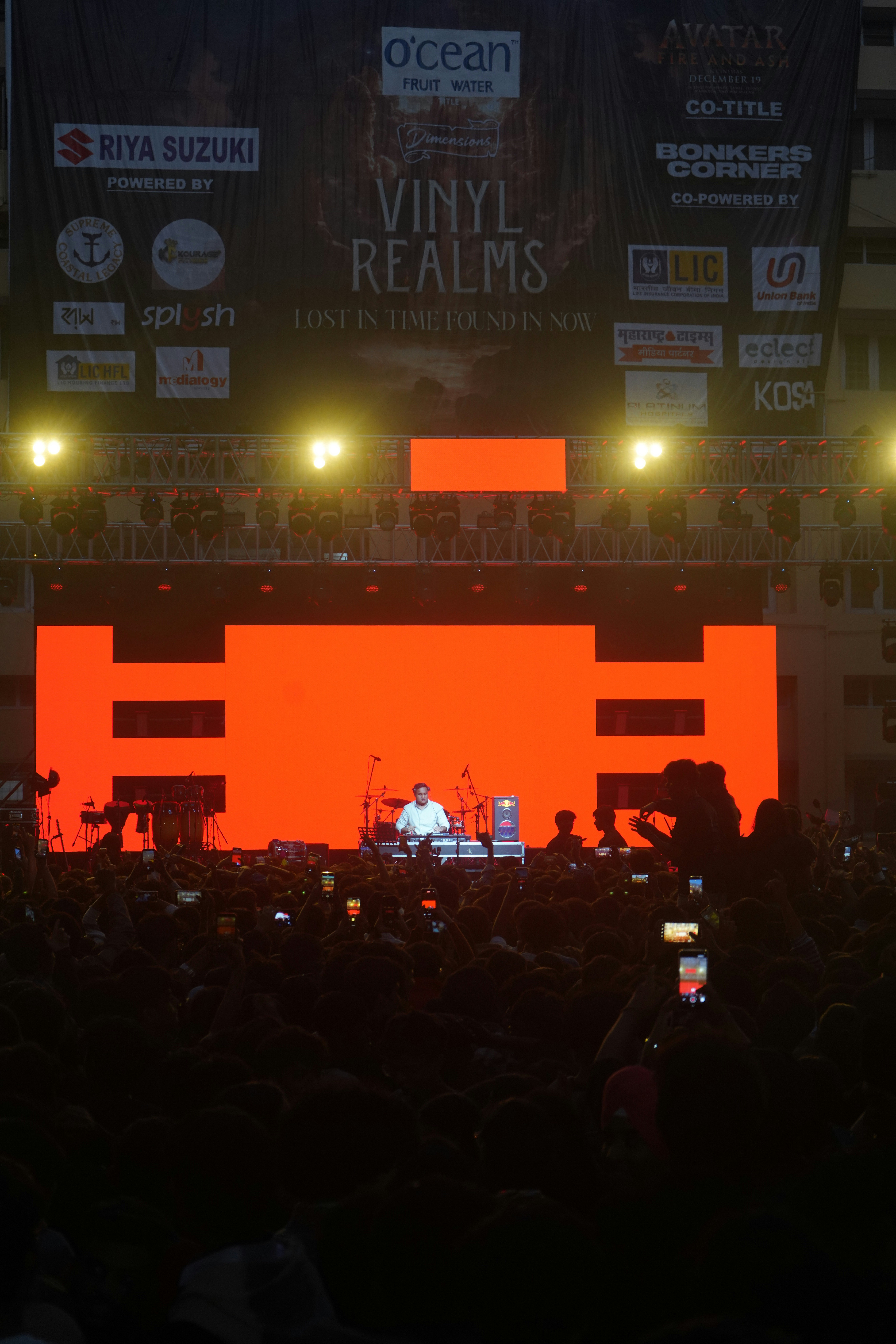 Bright Red Stage Mosaic: A DJ Sparks the Night
