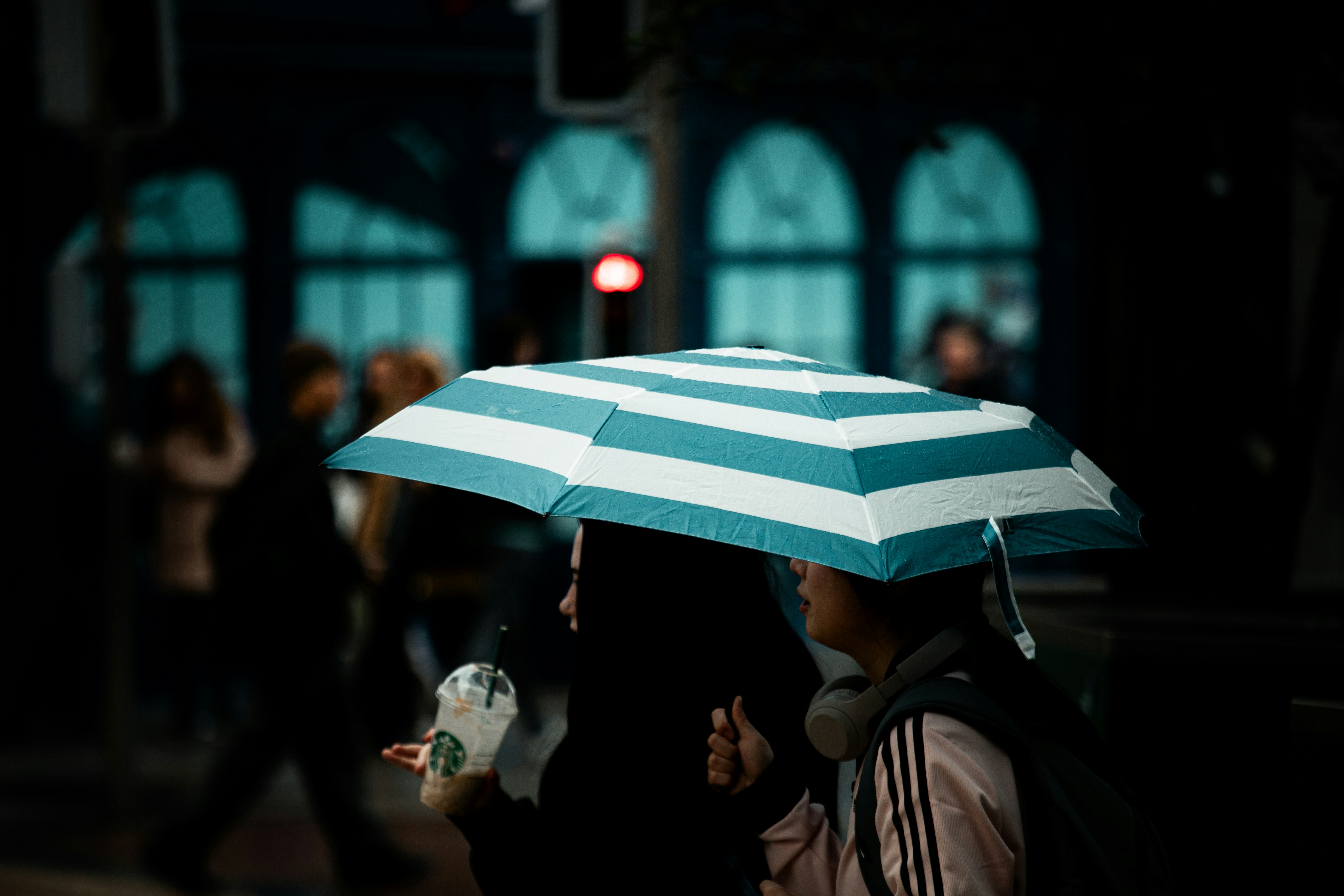 Umbrella in the Rain: Neon Backdrop and Moving Portrait