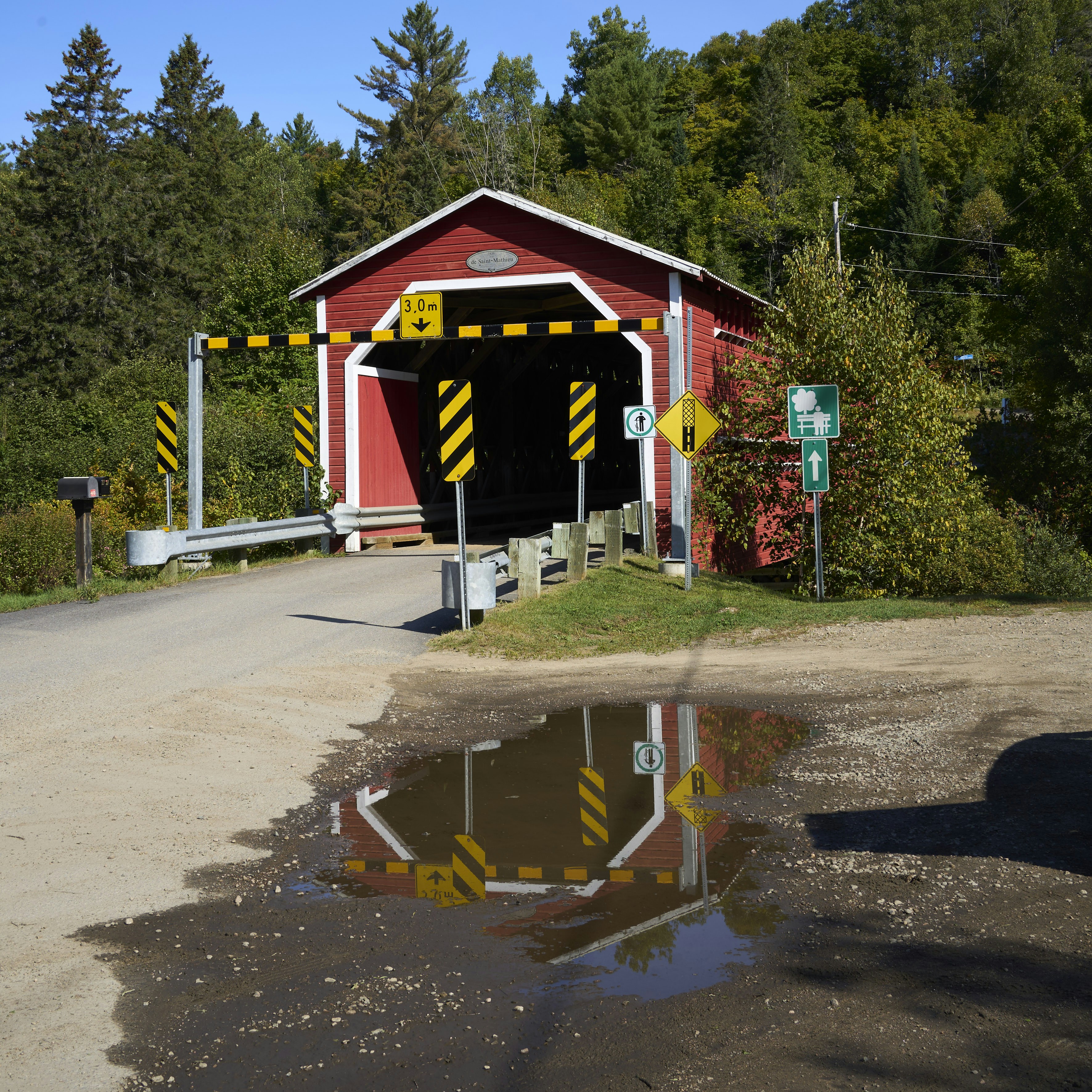Red Covered Bridge Reflections at a Quiet Crossing