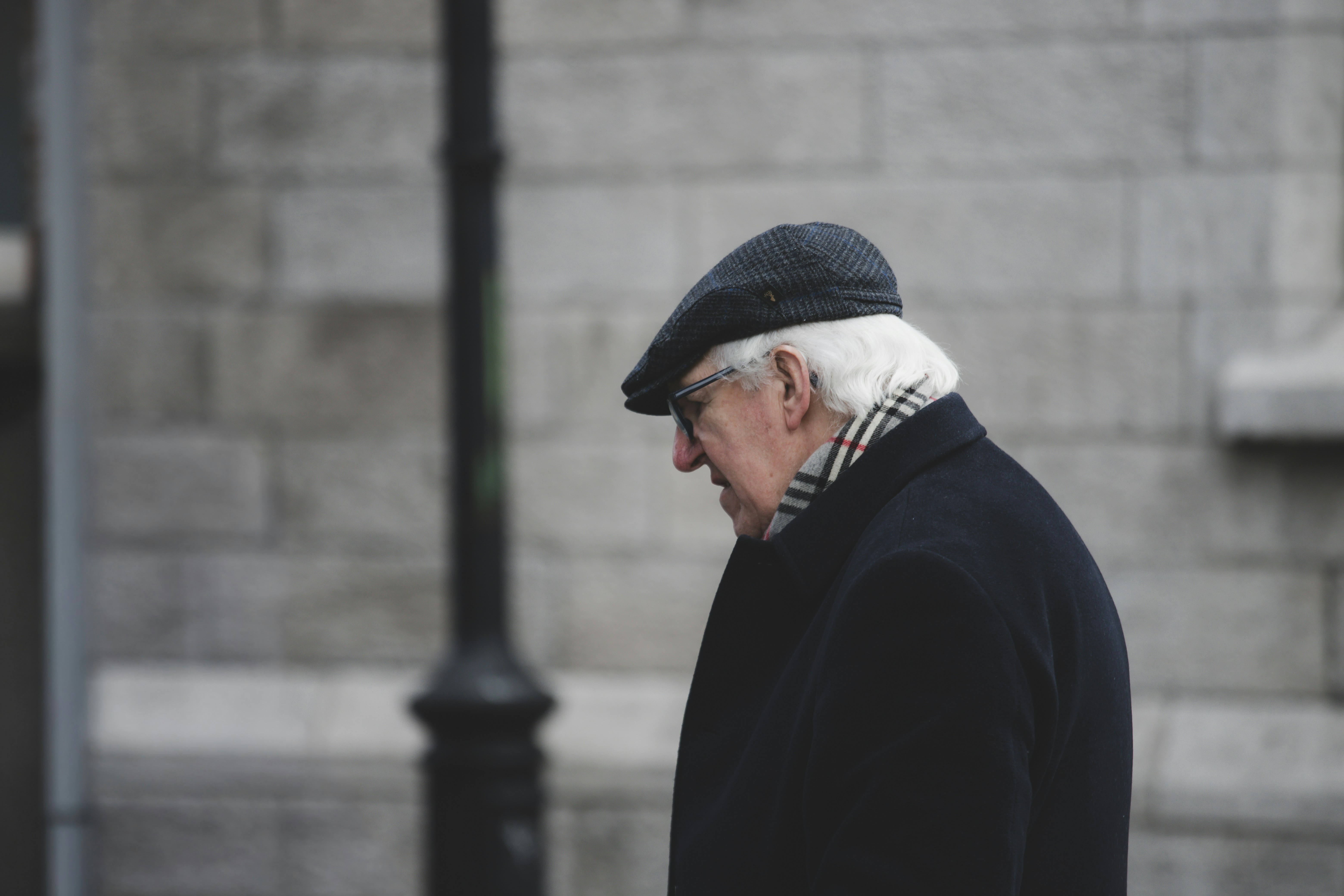 Winterward: An Aging Gentleman in Profile on a City Street