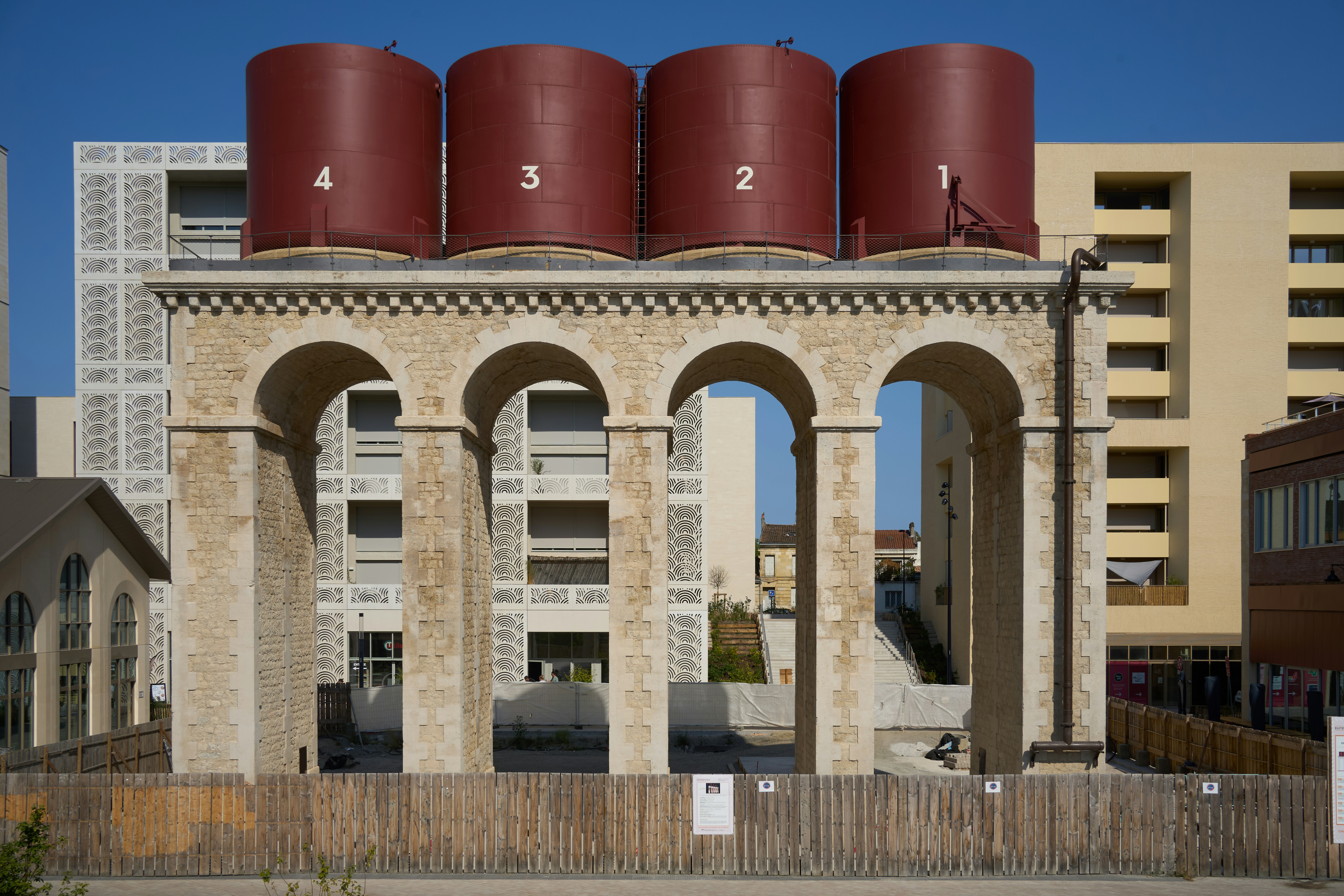 Stone Arches and Red Water Tanks: A Quiet Campus Gate
