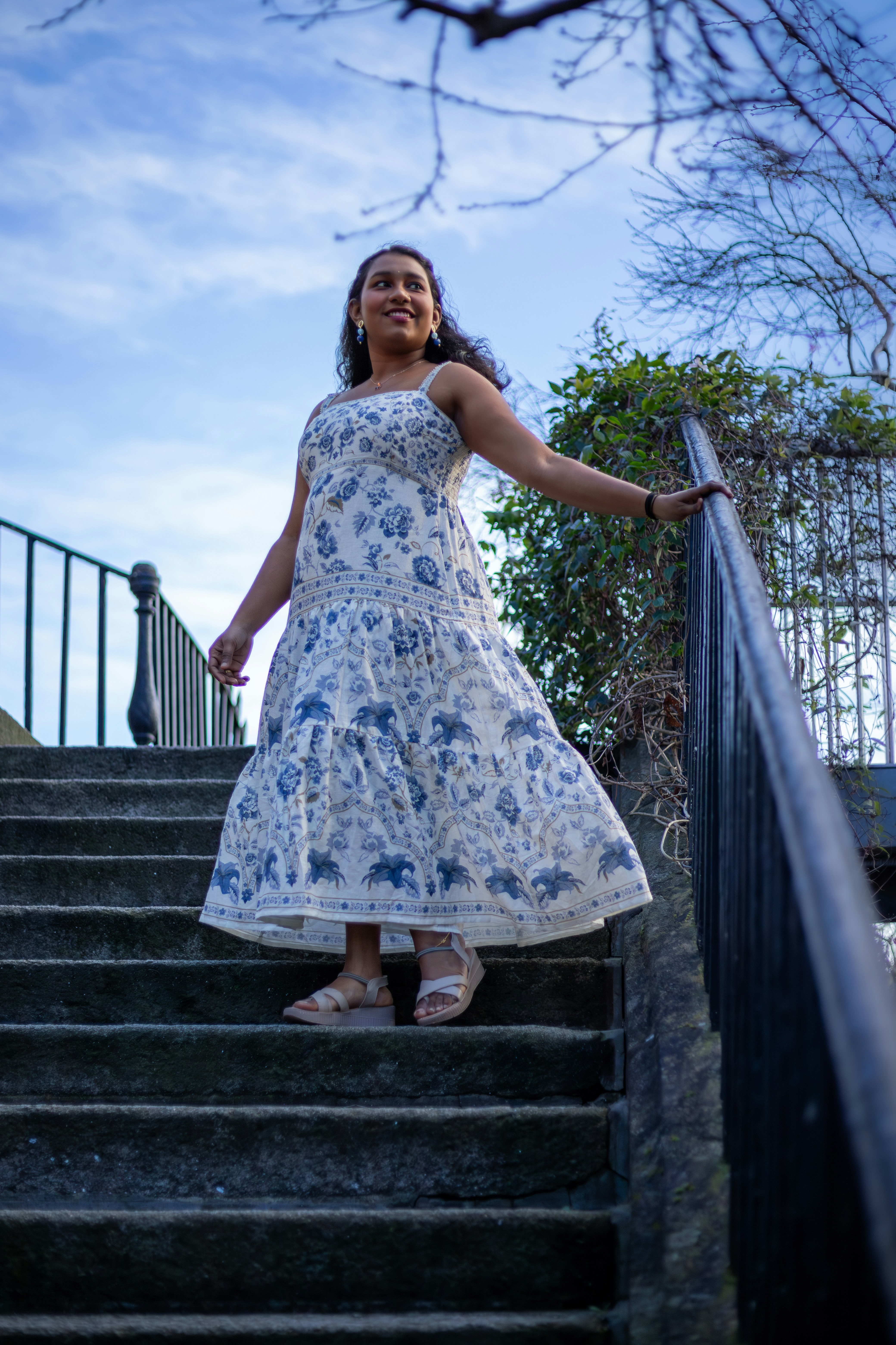 Grace on the Steps: A Sunlit Portrait in Blue-White Florals