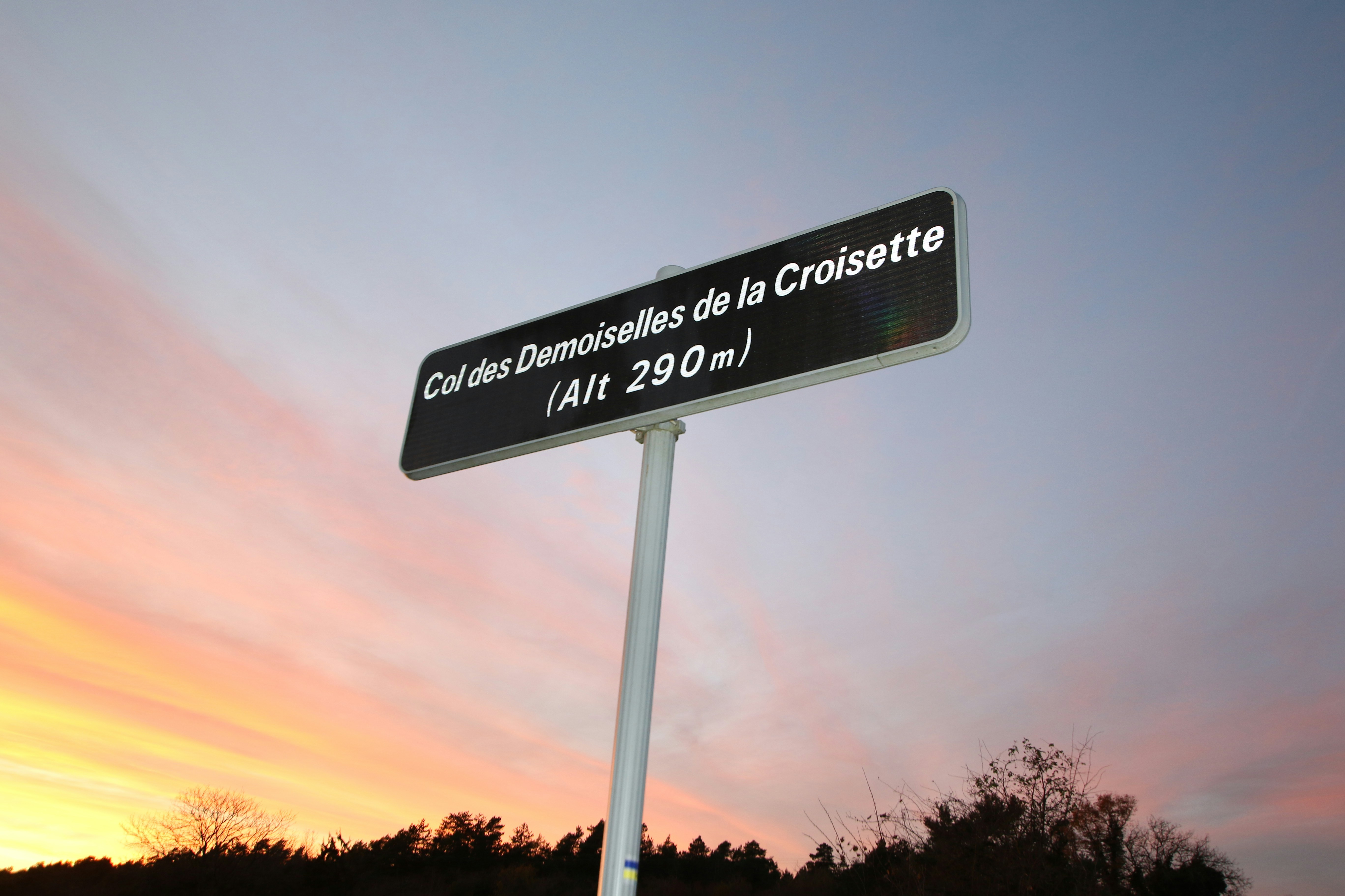 Signpost at Sunset: Distant Croissette in Silhouette