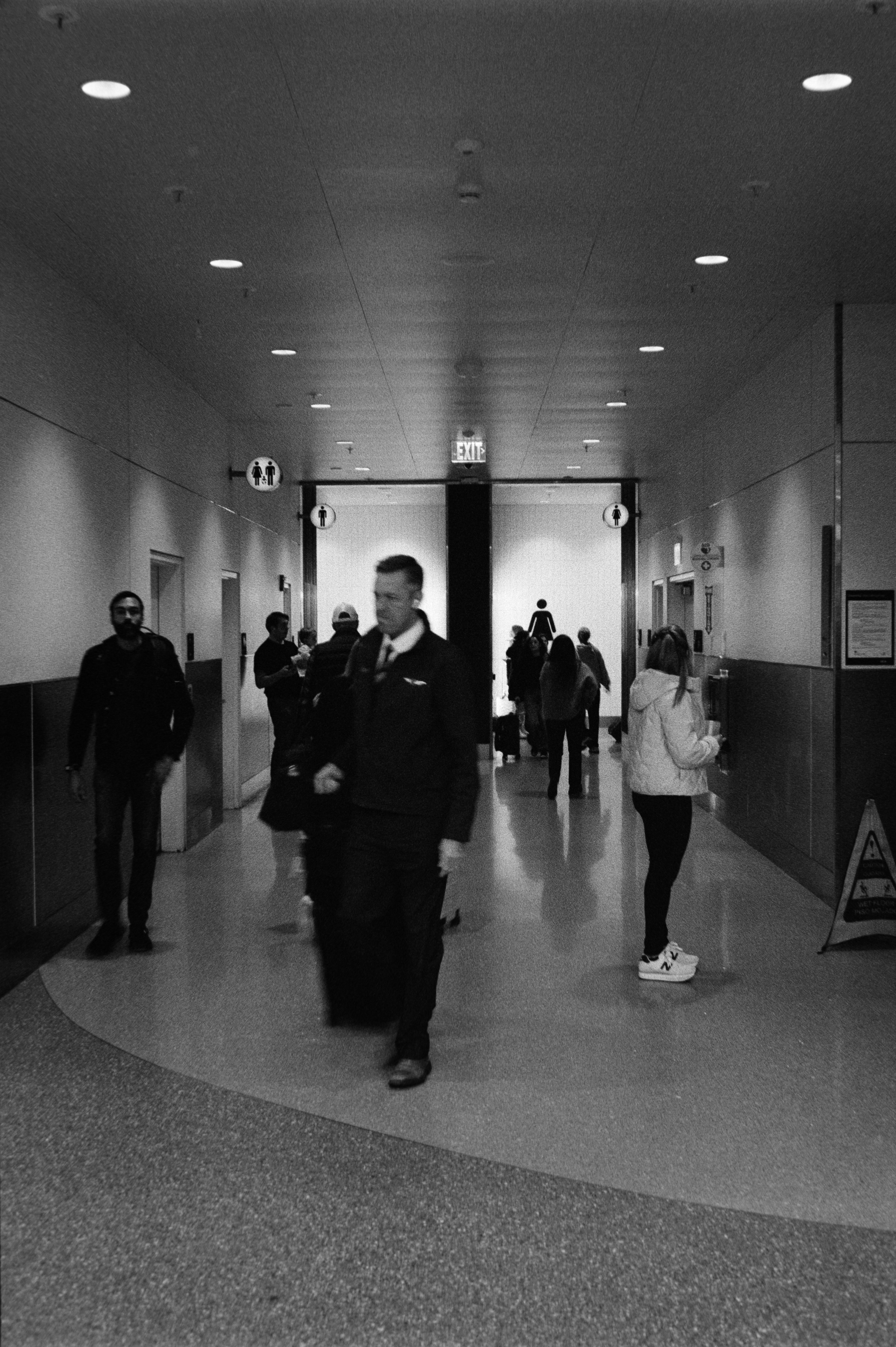 Mid-Hall Echo: Anonymity and Motion in a Monochrome Transit Corridor