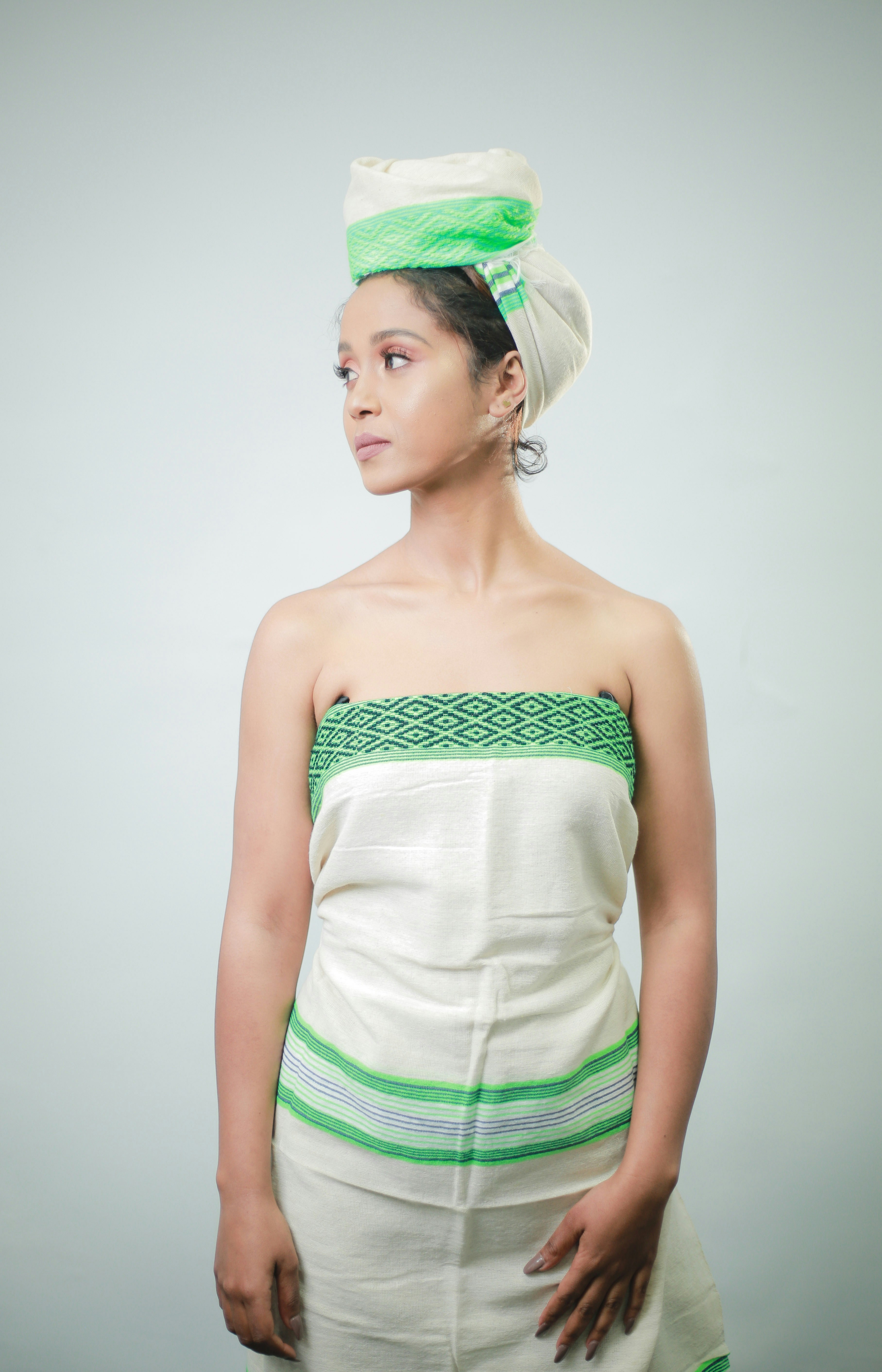 Graceful Poise in White and Green: A Portrait in Traditional Wrap
