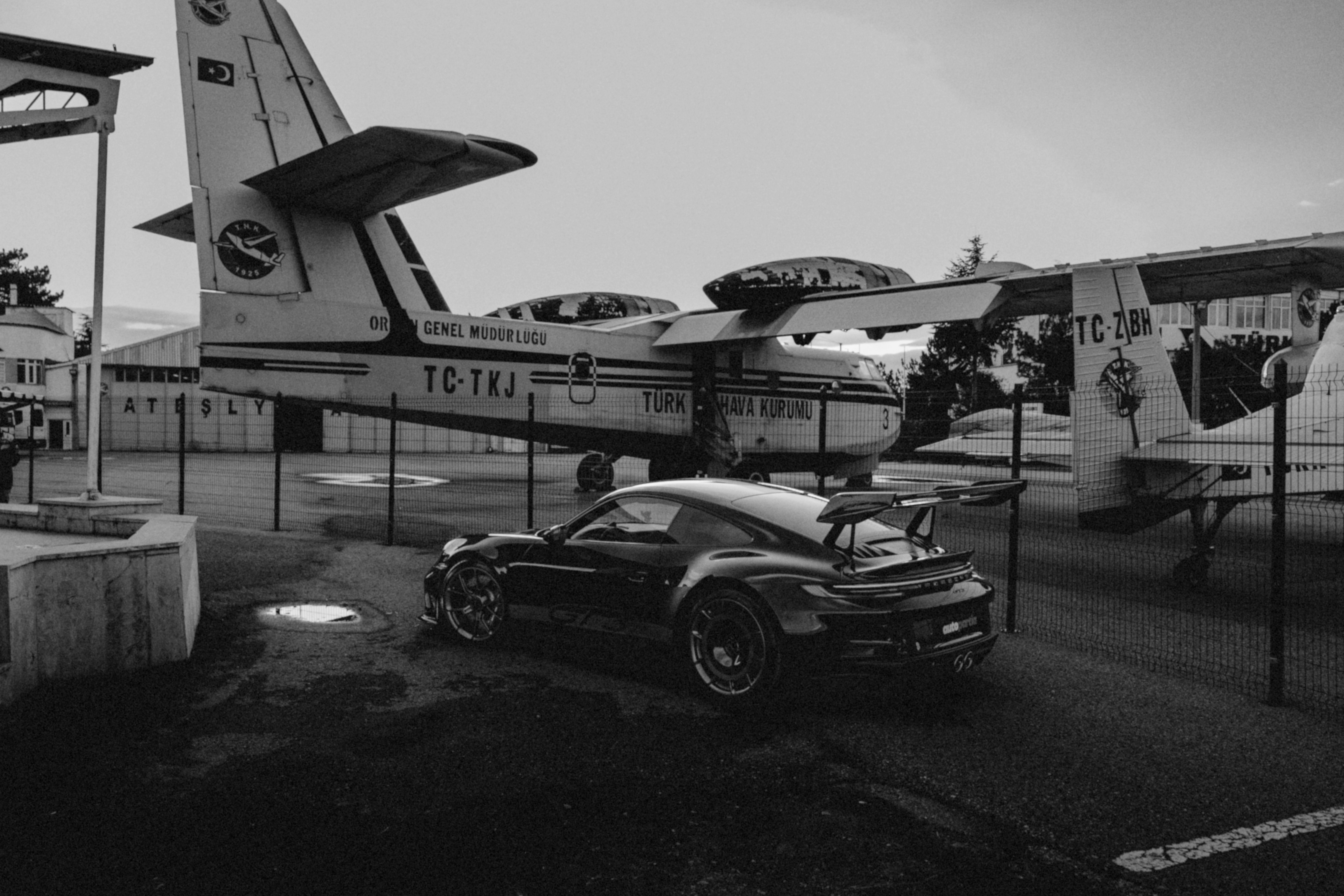 Dark Horse at the Edge of Aviation: A Car Meet Under Cold Blue Skies