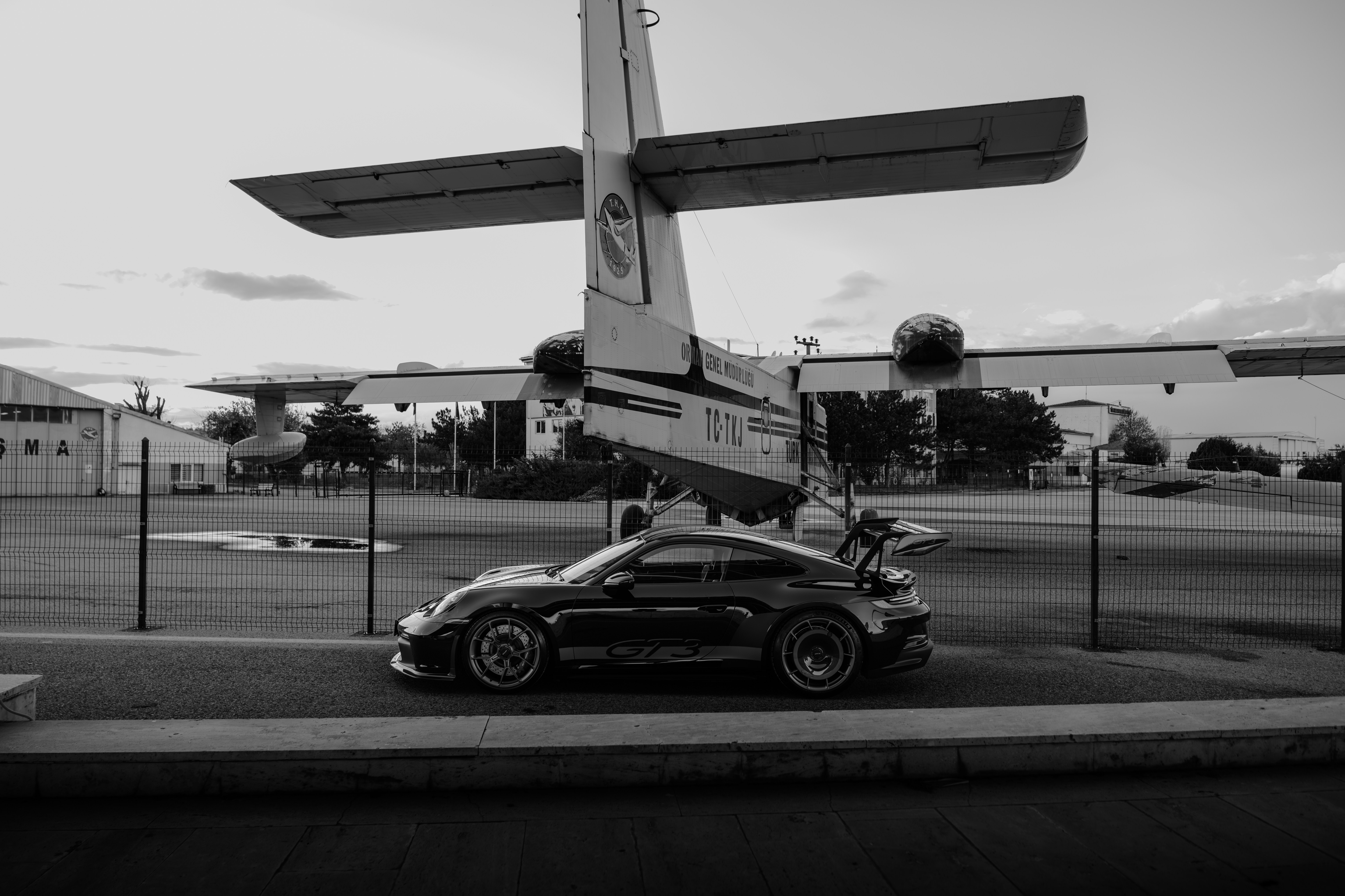 Lifted silhouette: a jet-tank car under a hovering winged transport