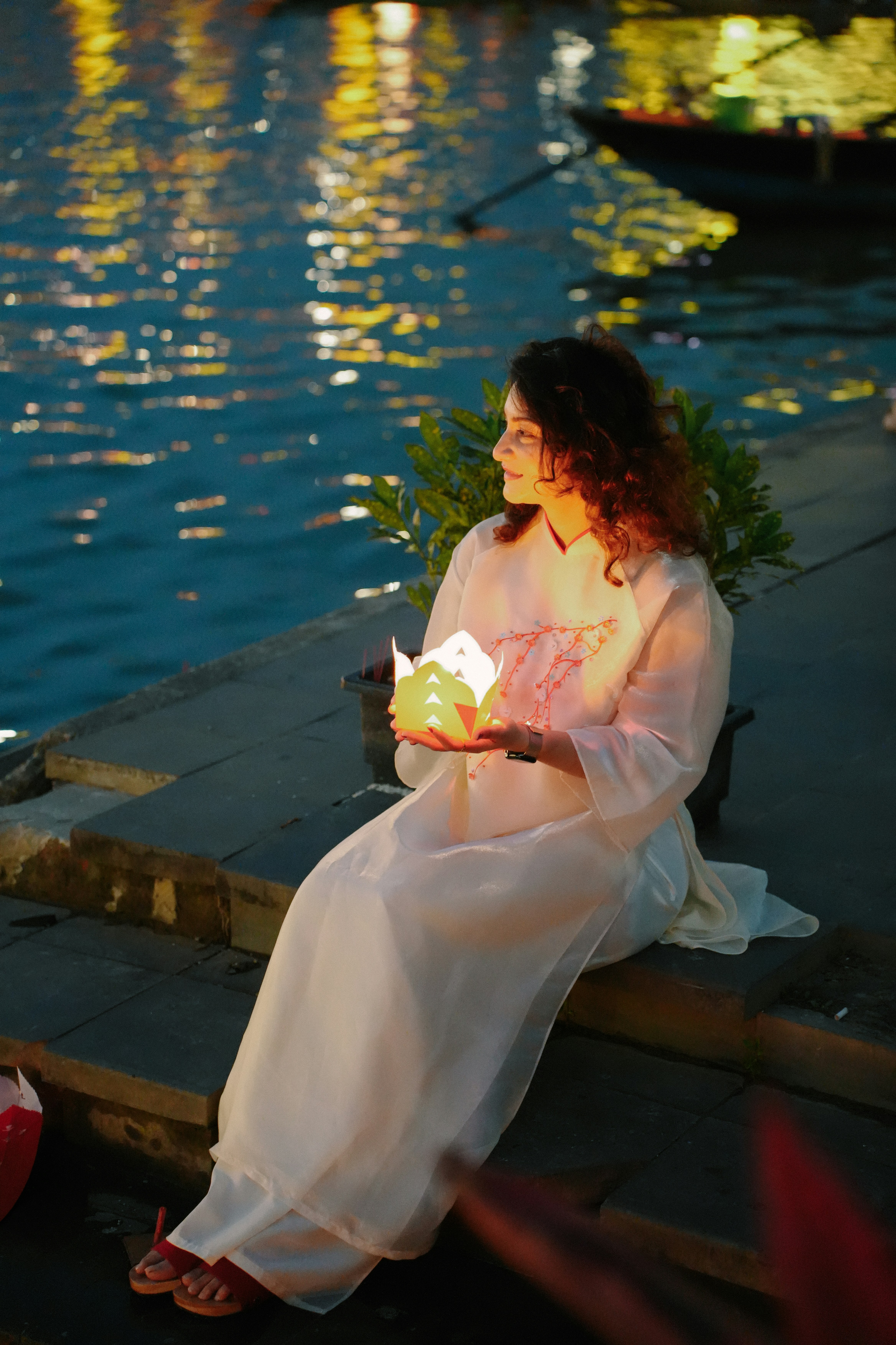 Soft glow by the river: a serene evening with illuminated paper lanterns