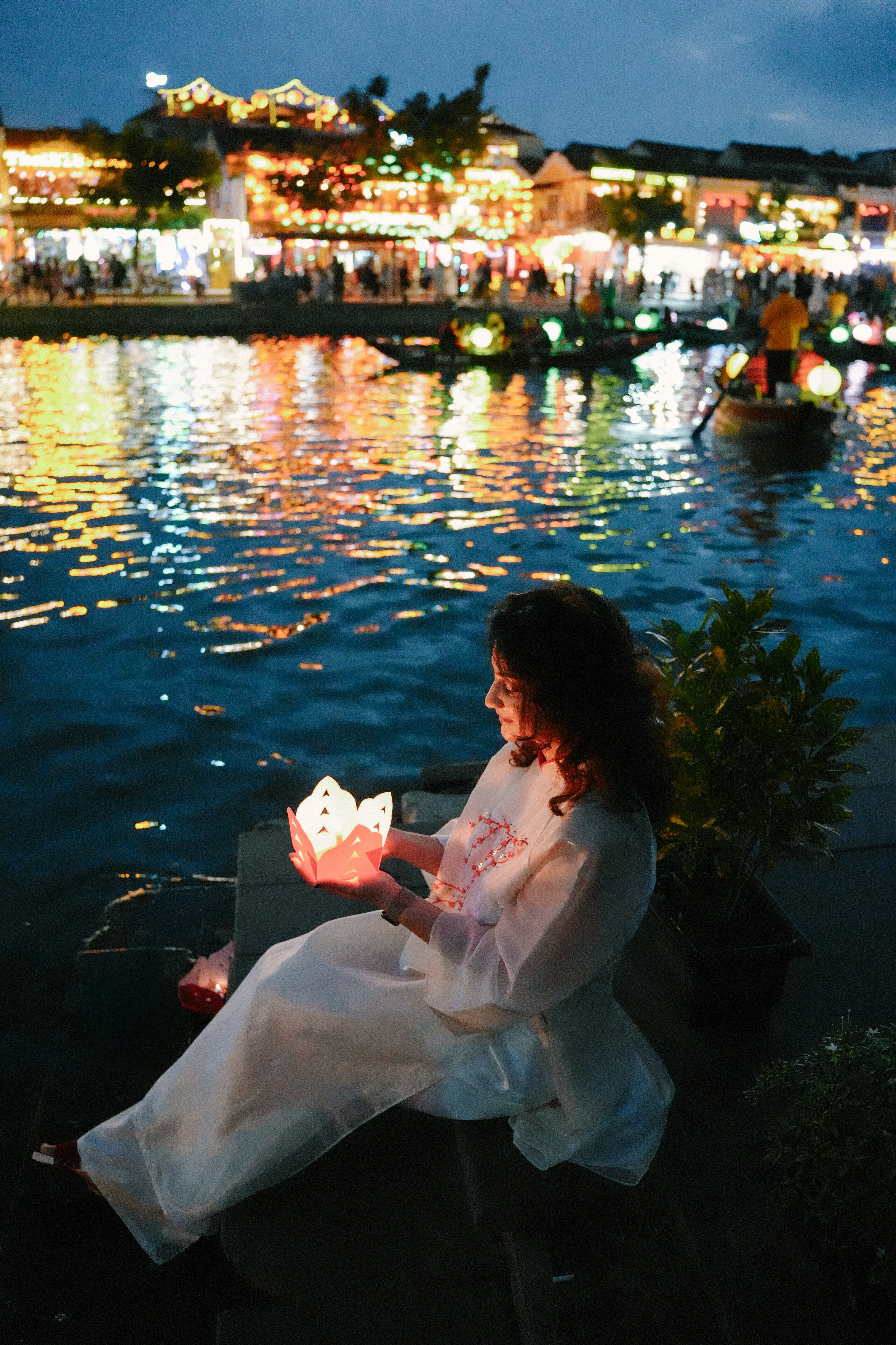 Glow of a Lantern at Dusk: A Woman by the Waterfront