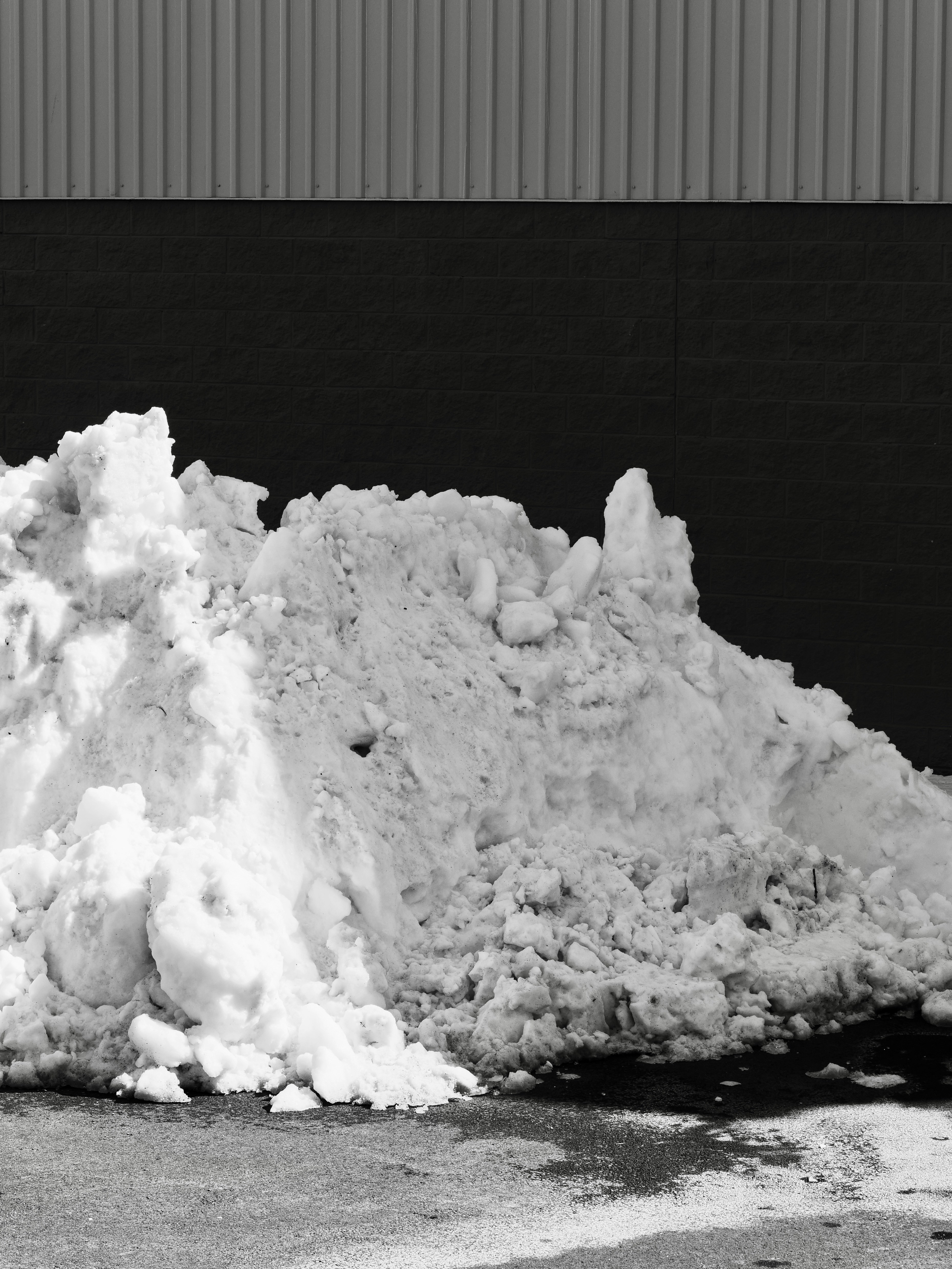 Snowy Heap at the Edge of a Dark Wall
