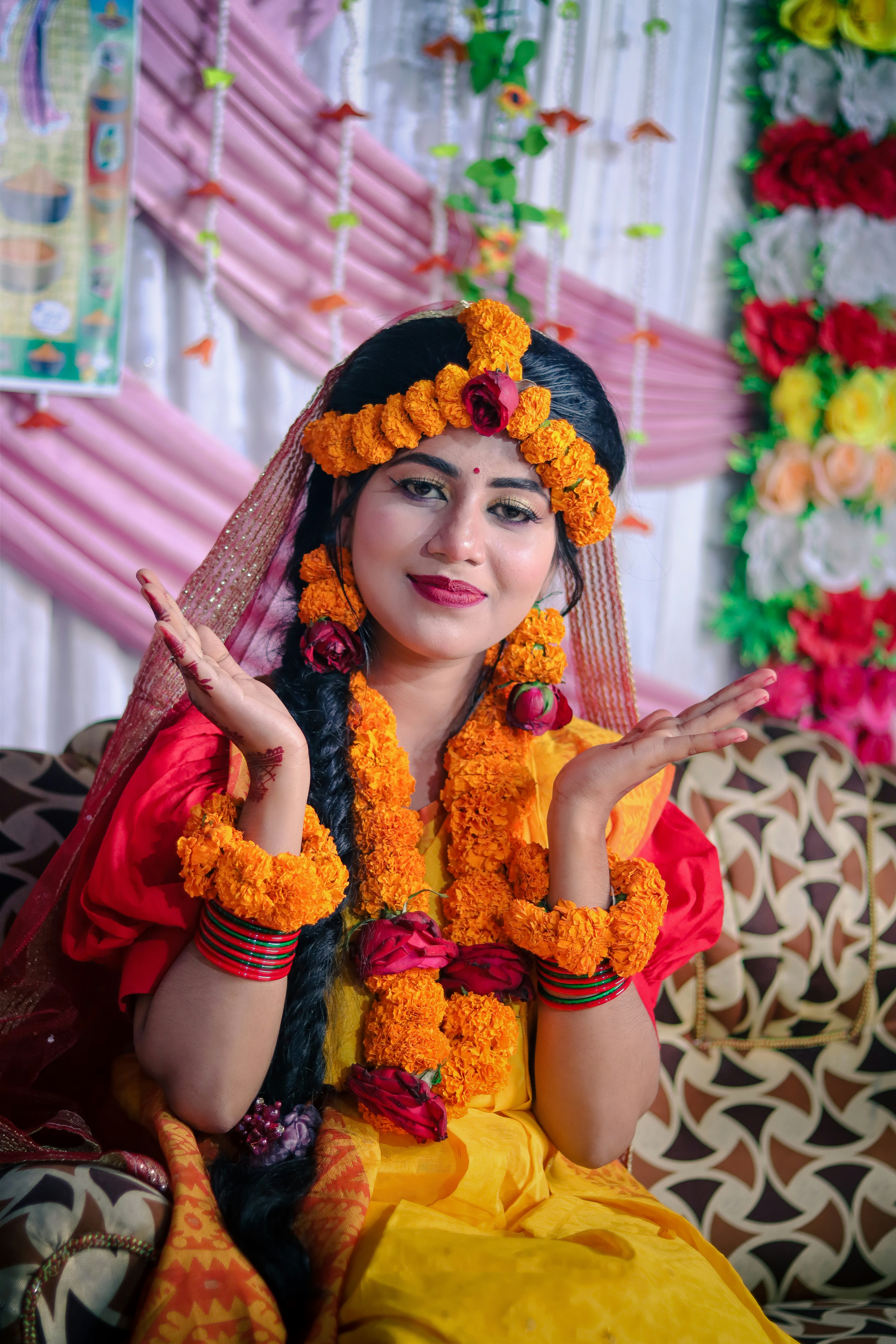 Garlands in Bloom: A Bride’s Cheerful Pose amid Festive Backdrop