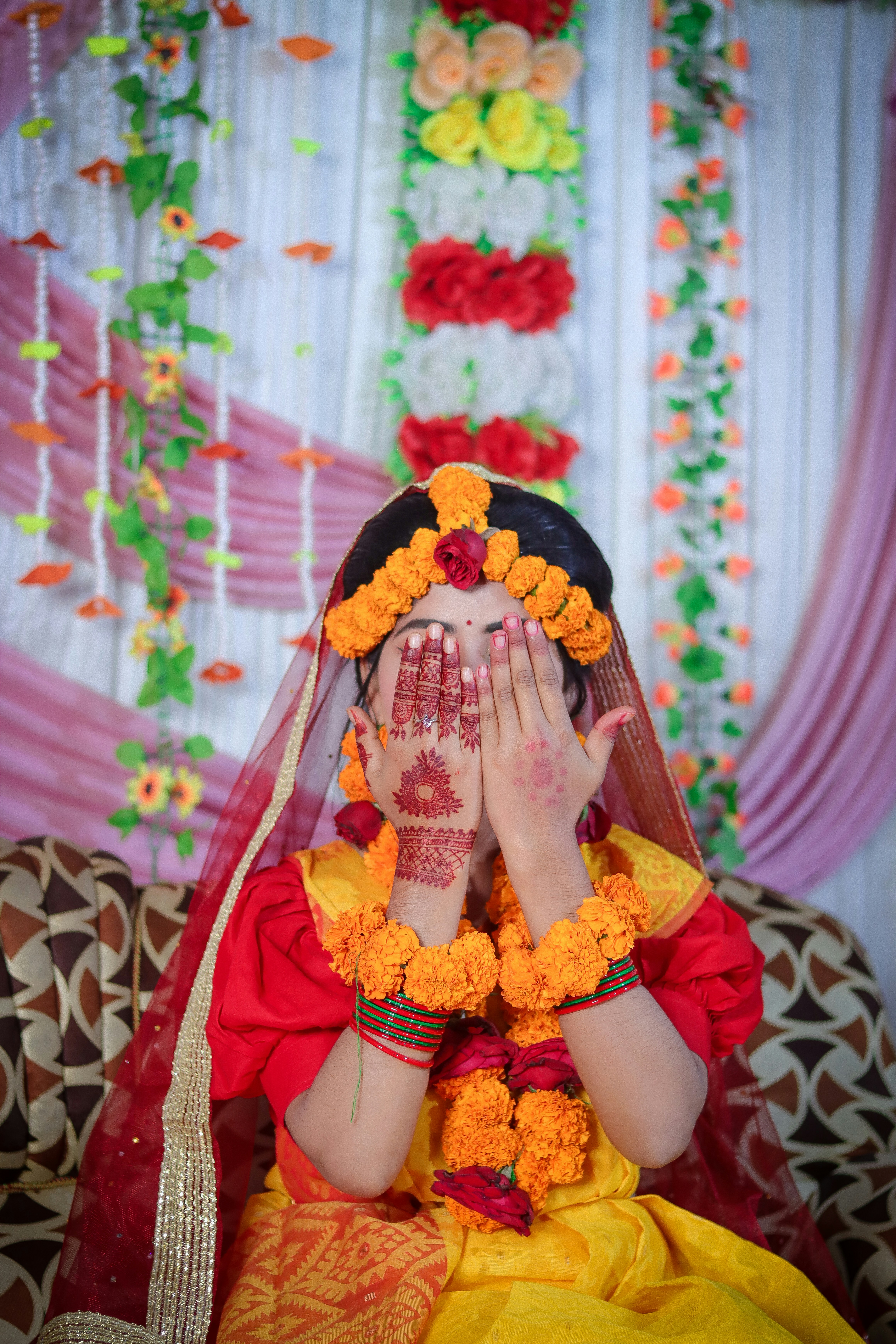 Bride in Bloom: A Veiled Smile Behind Hennaed Hands