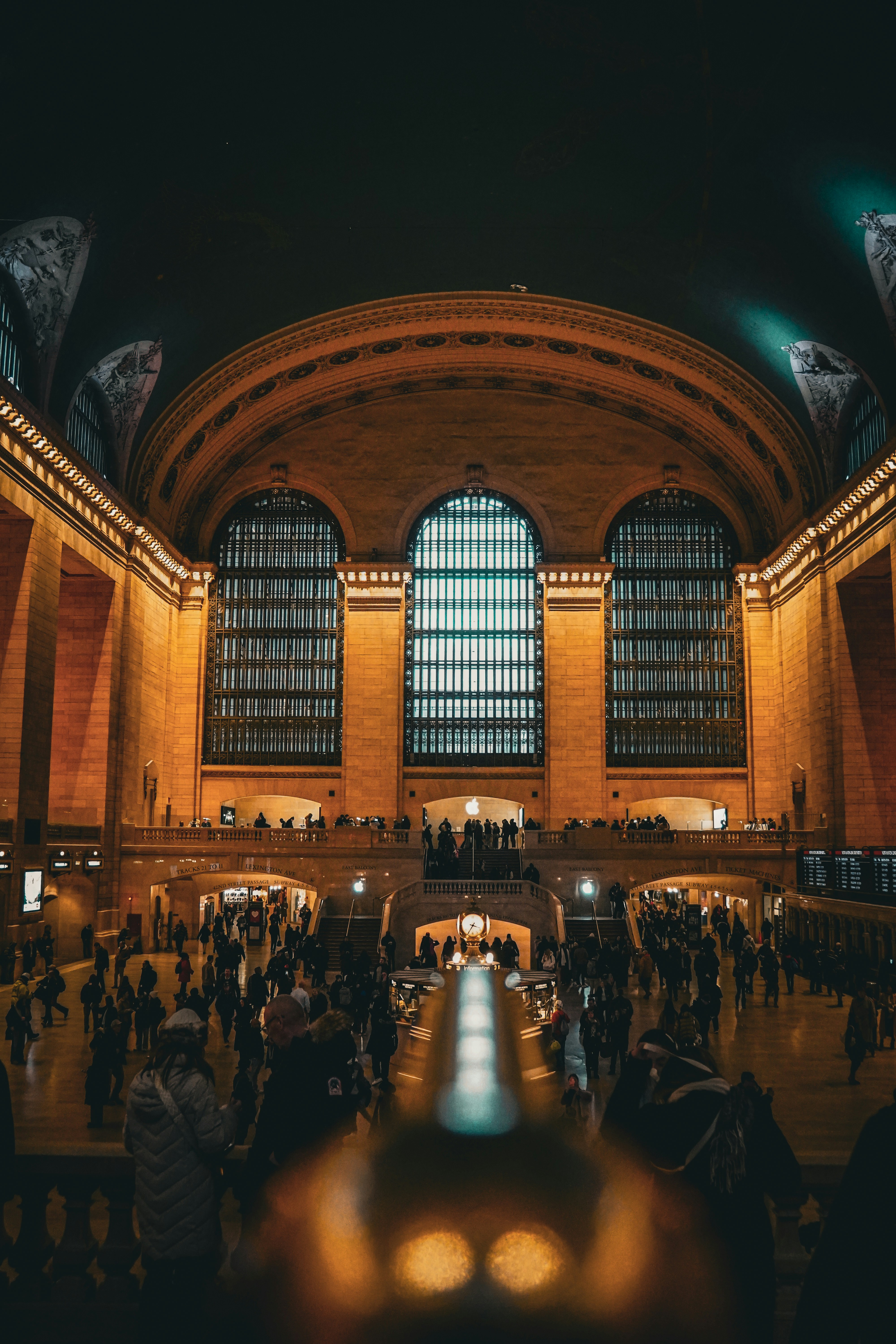 Midnight Grandeur: People Gather Beneath a Grand Arched Hall