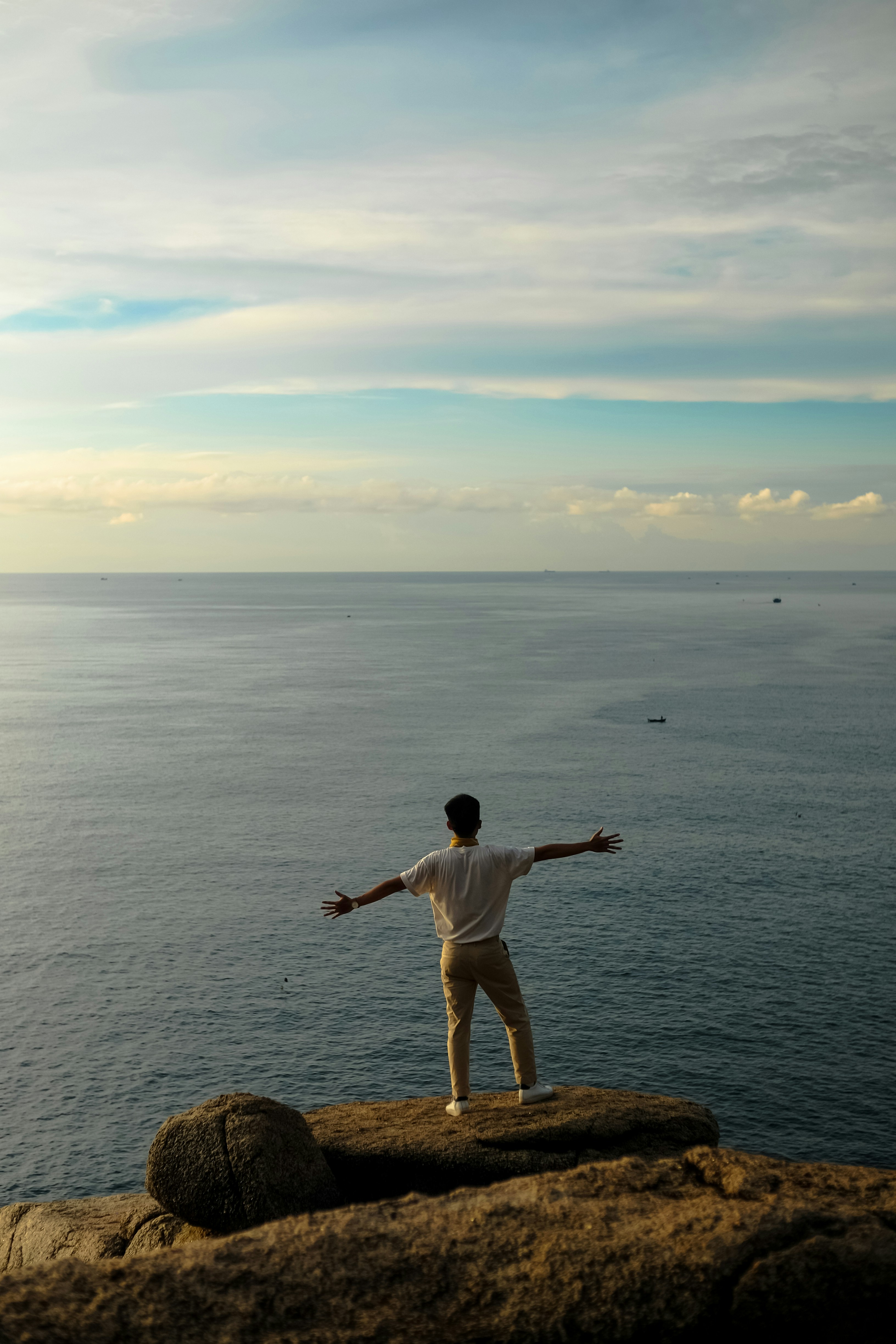 A Stance at the Edge: Person Embracing the Sea's Horizon