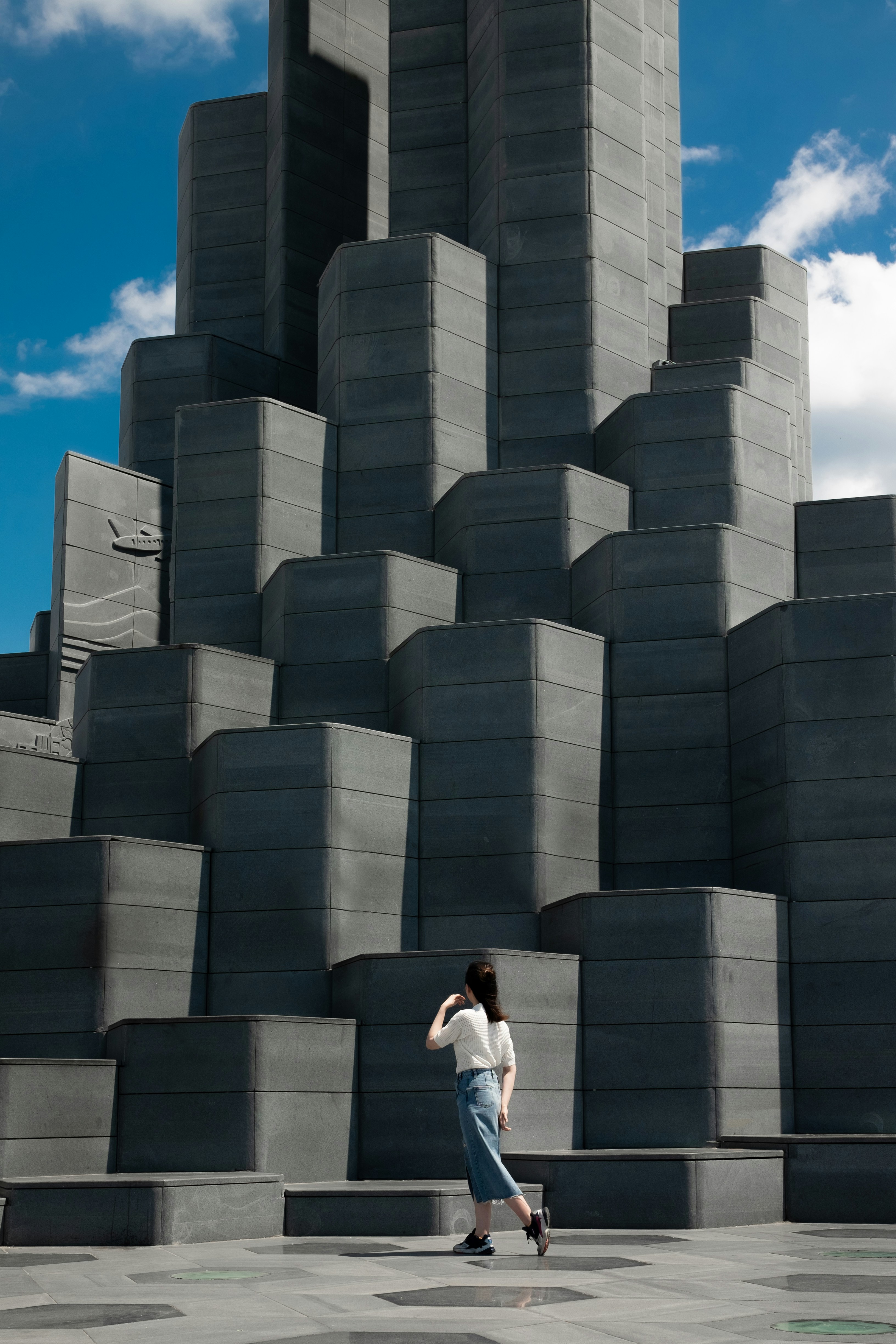 Against the Monolithic Steps: A lone figure among stacked towers
