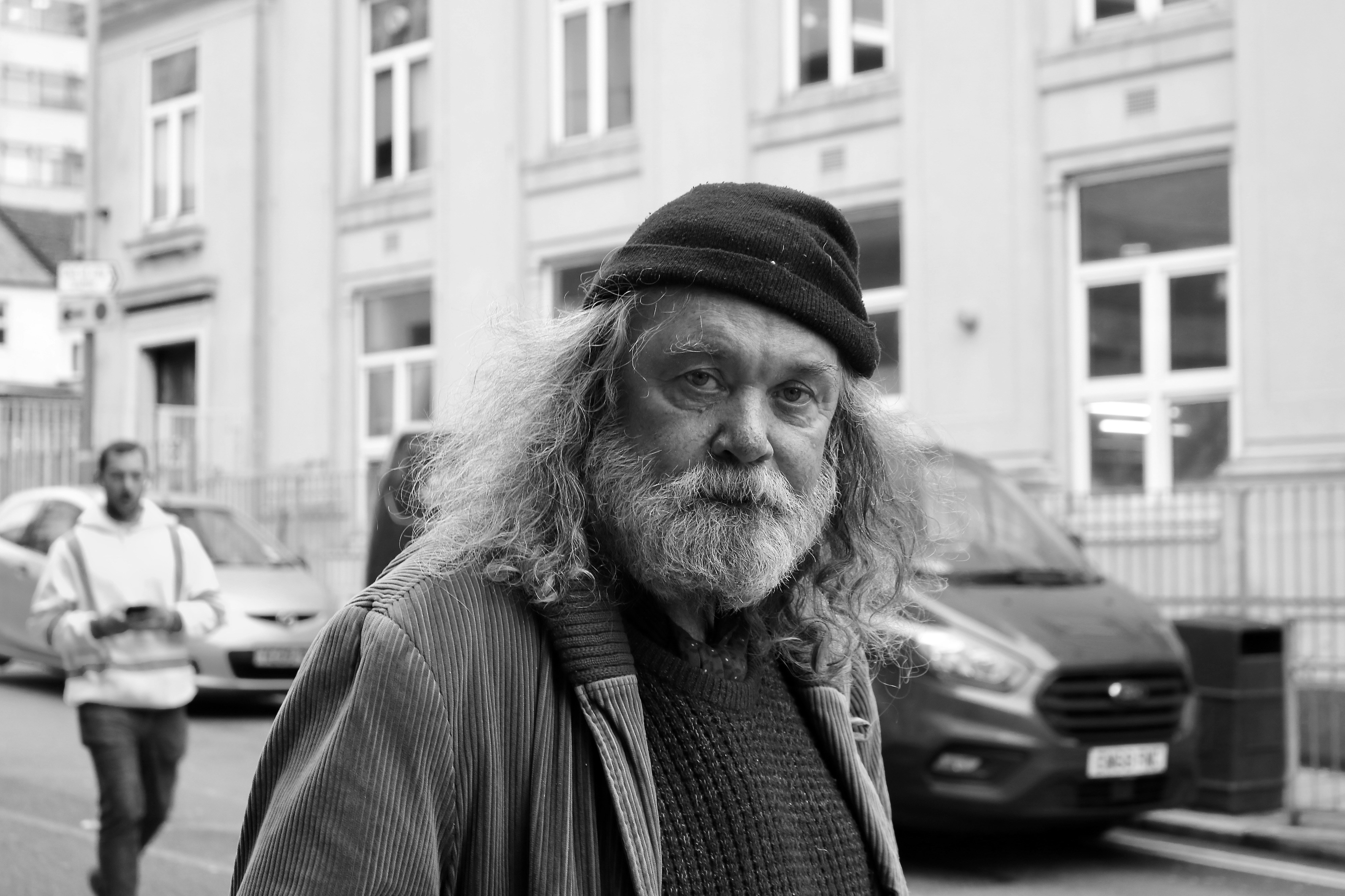 Weathered Gaze on a City Street