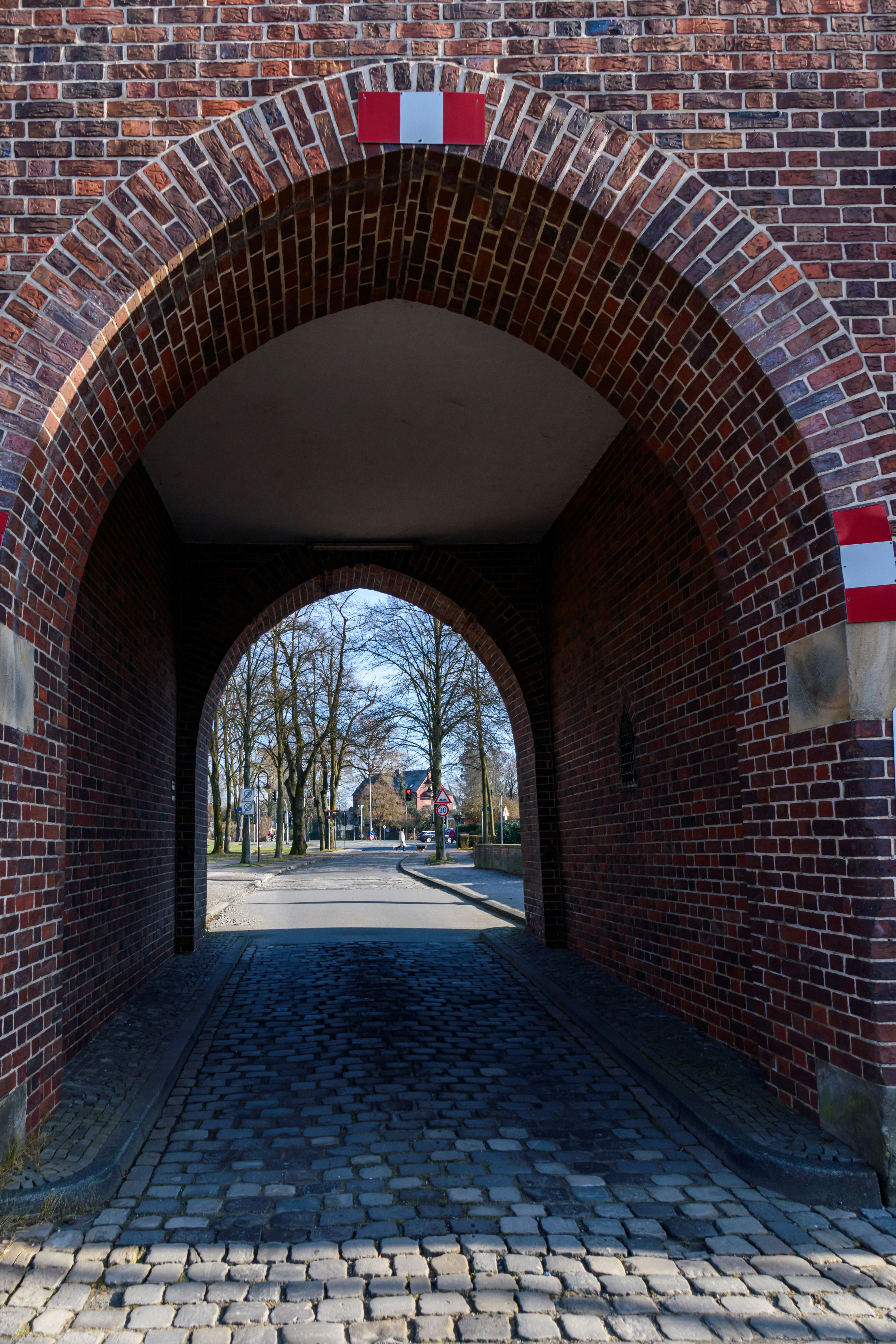 Brick Archway Tunnel to Silk-Cobbled Street