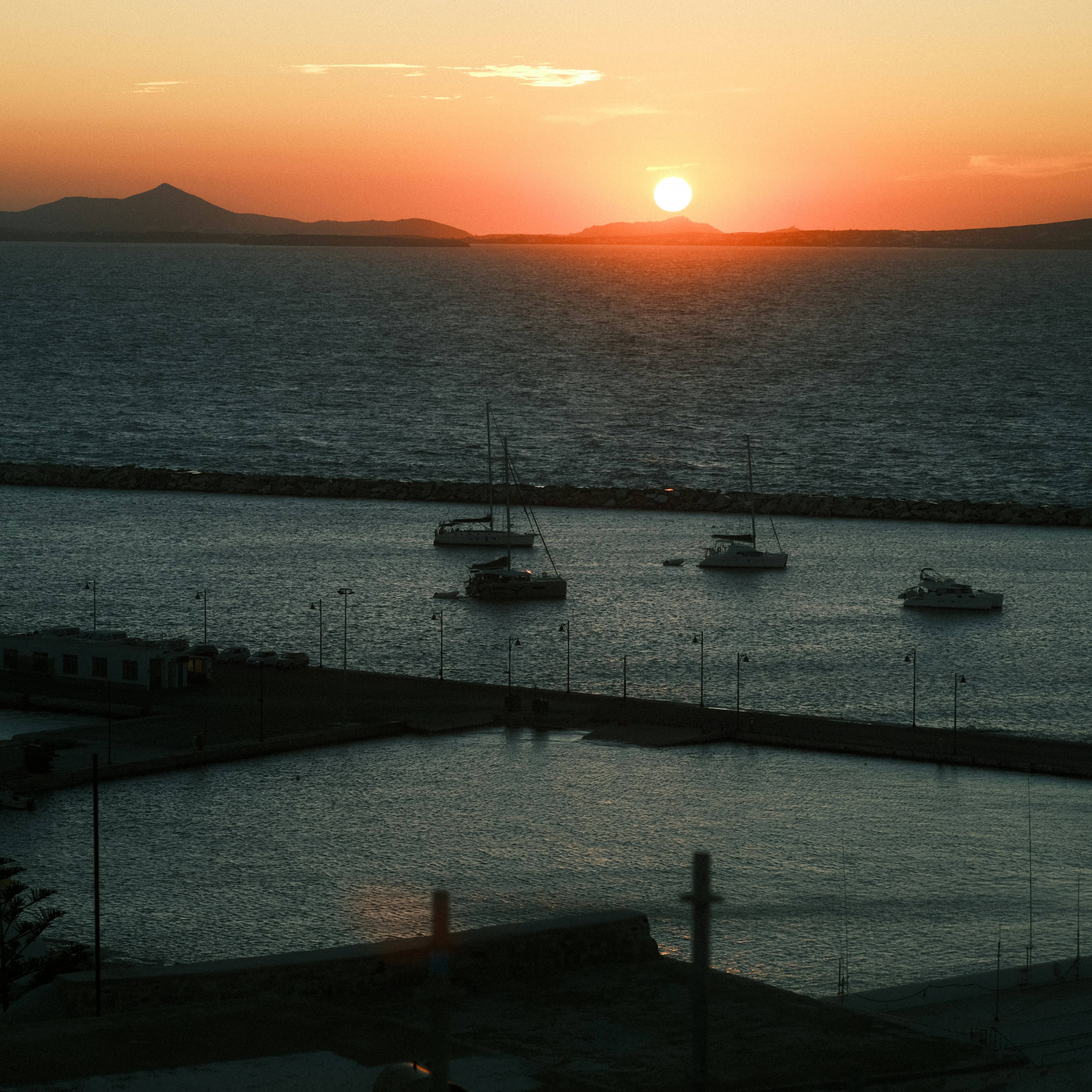 Sunlit Harbor at Dusk with Silhouetted Boats