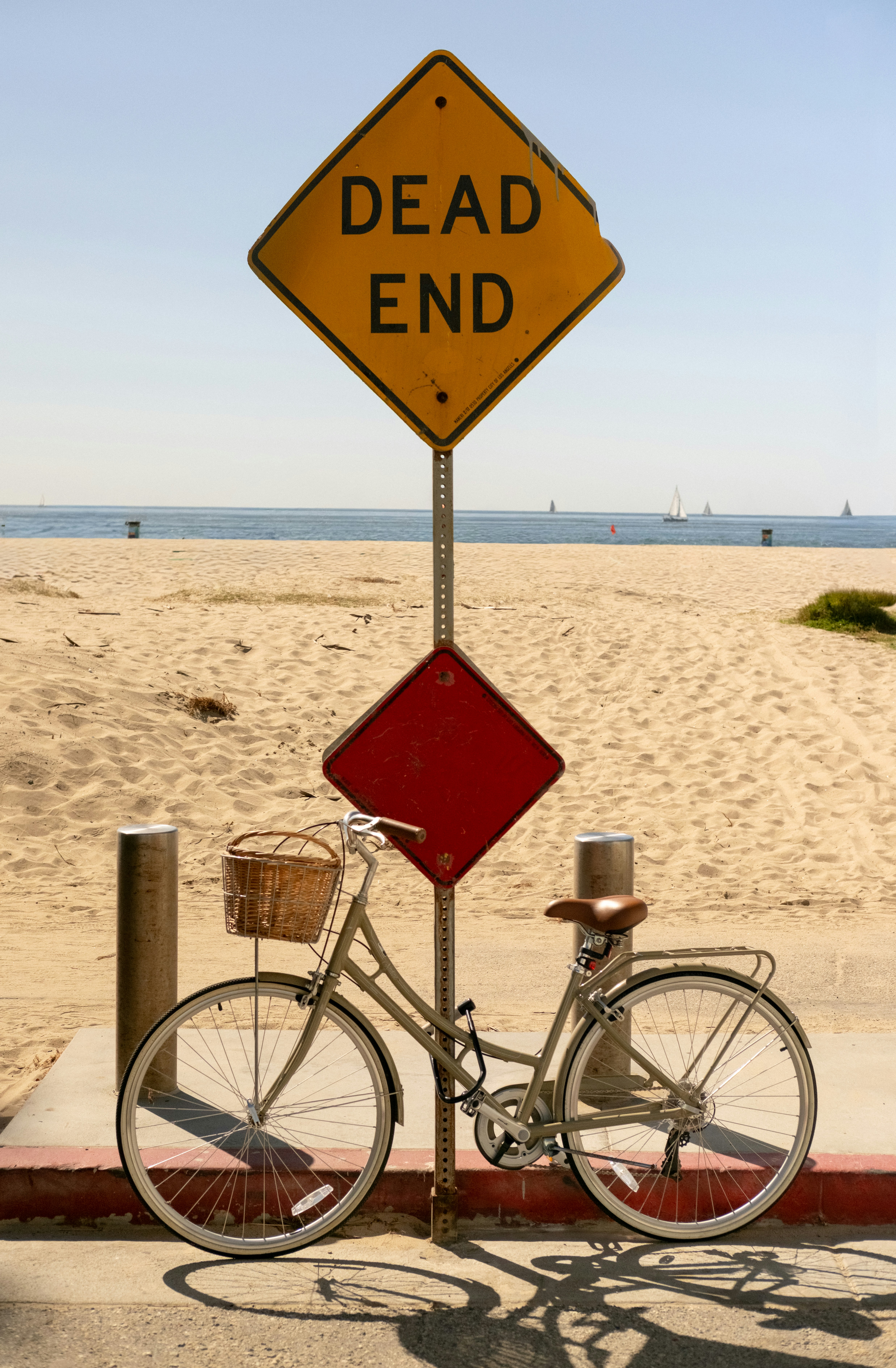 Beachside Signpost with Bicycle Under a Dead End Banner