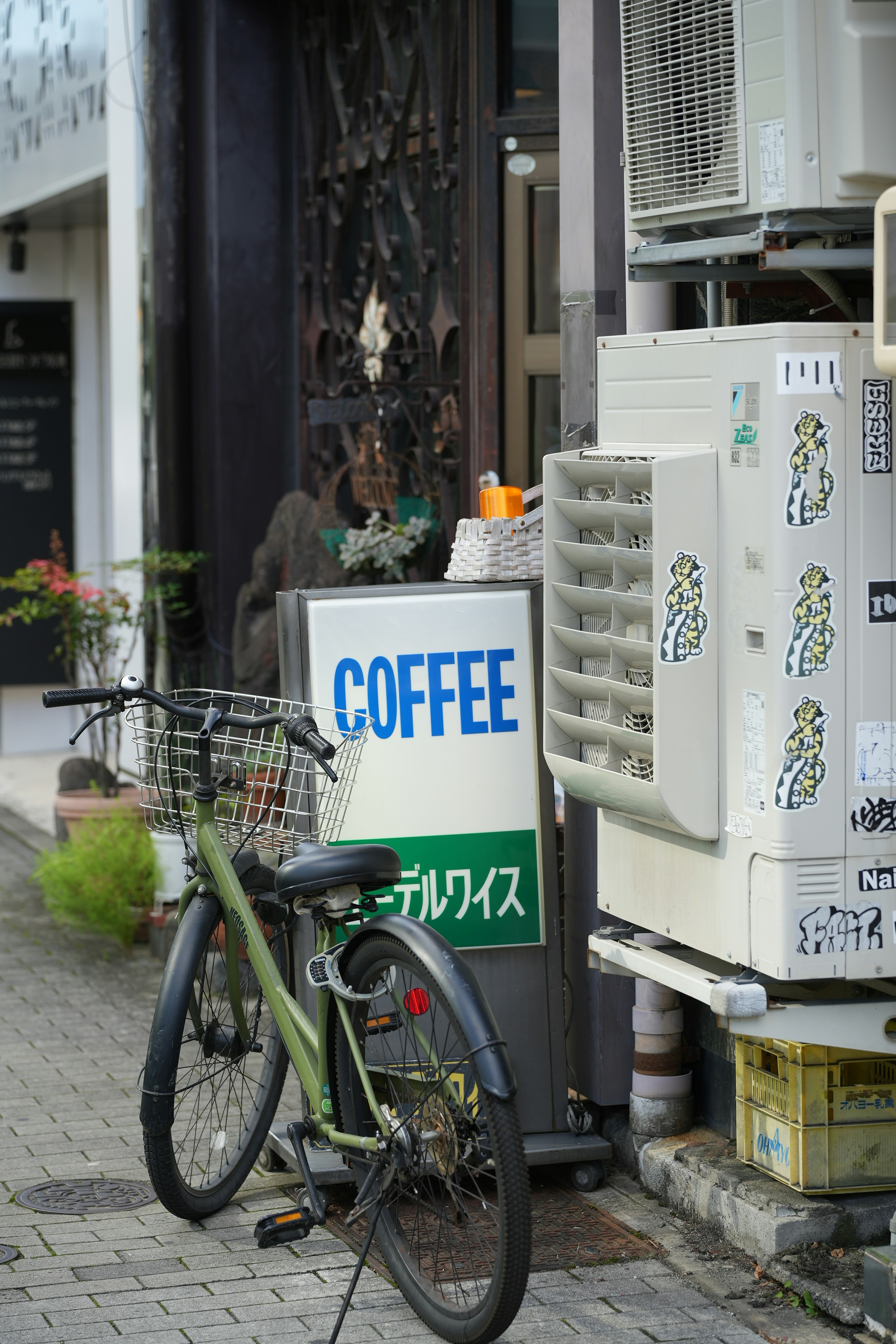 Coffee Shop Corner: Bicycle and Sign Between Stack of Goods